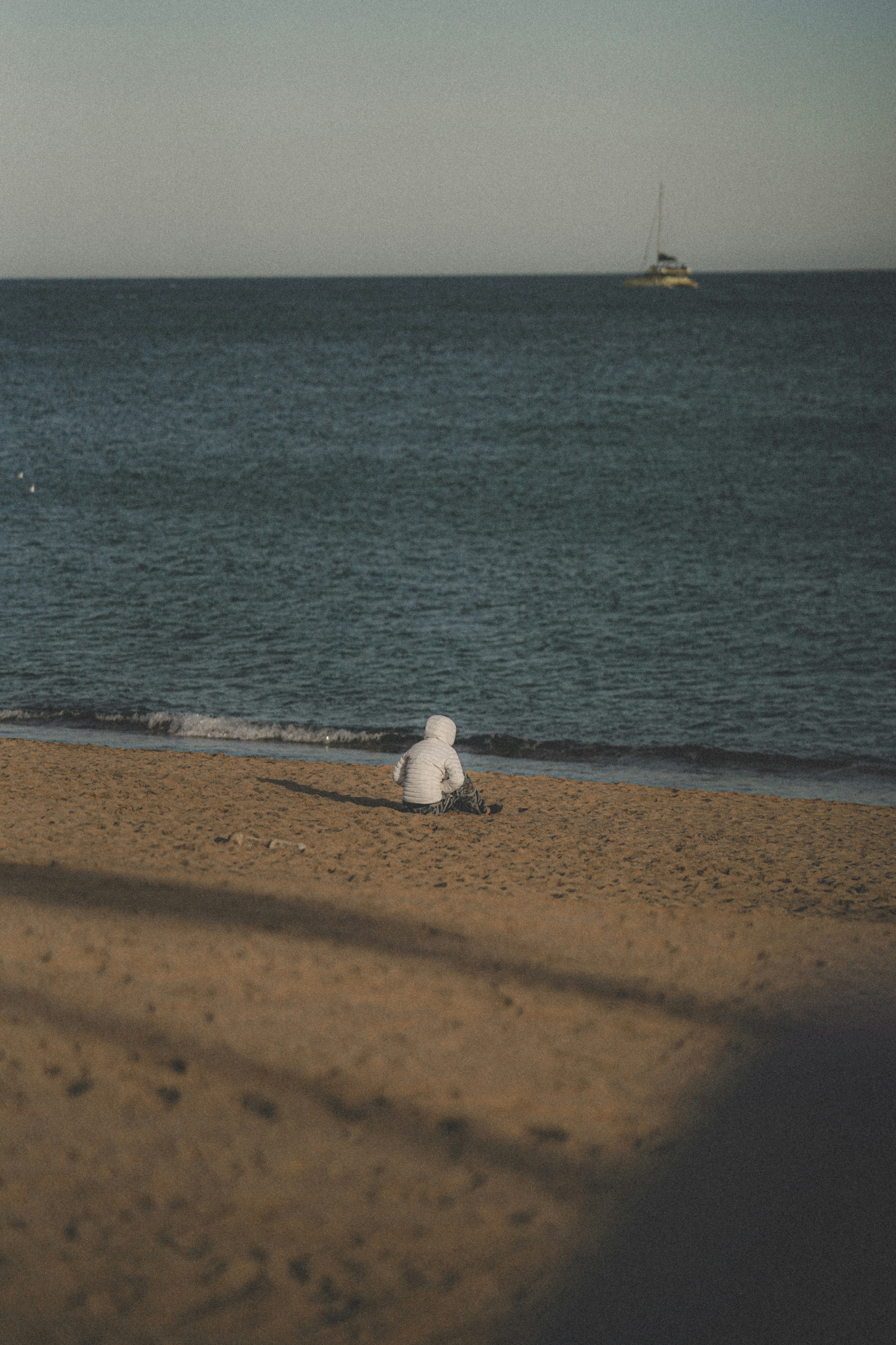Solitary Reef: a lone figure on the horizon of sea and sand