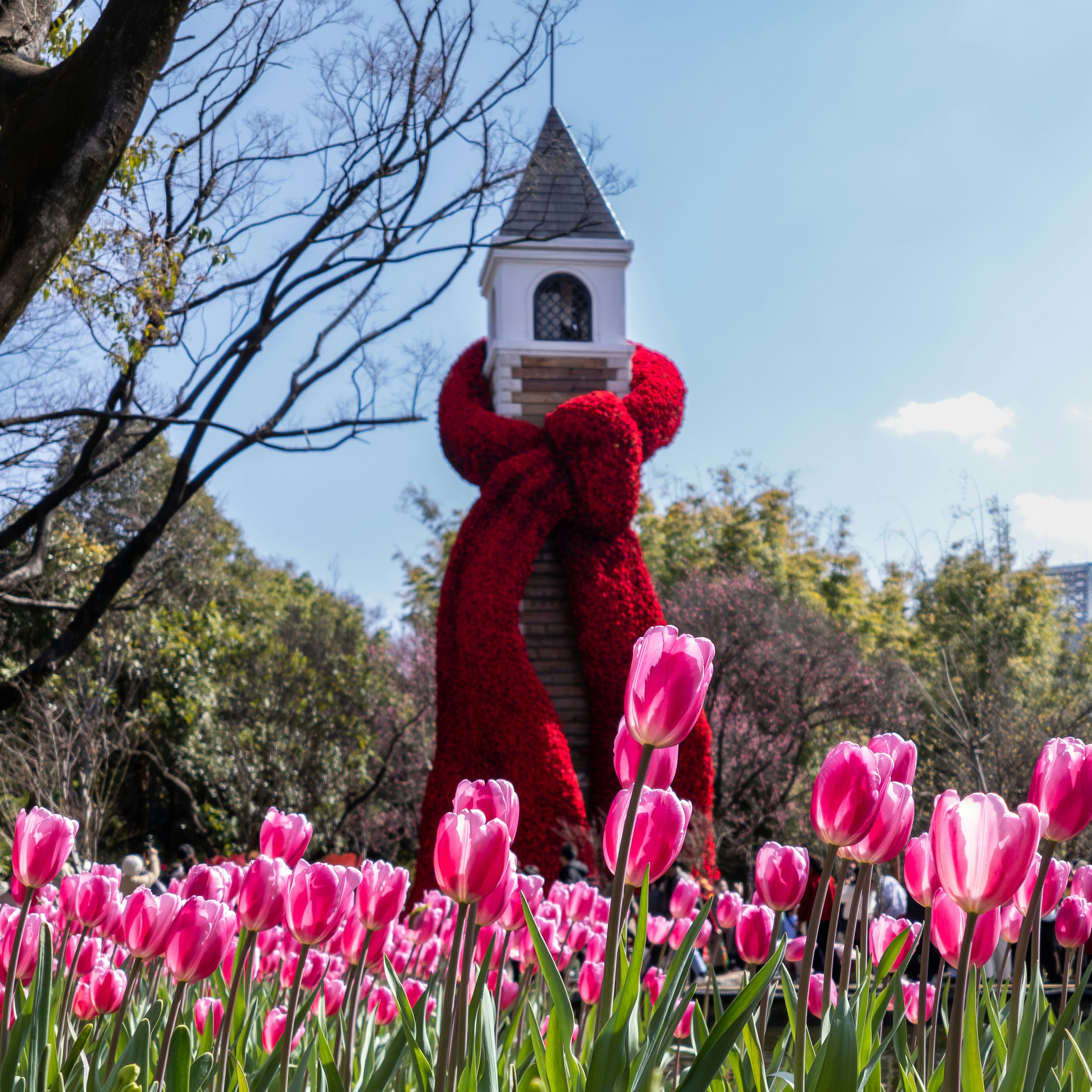 Red Velvet Giraffe Tower among a Field of Pink Tulips