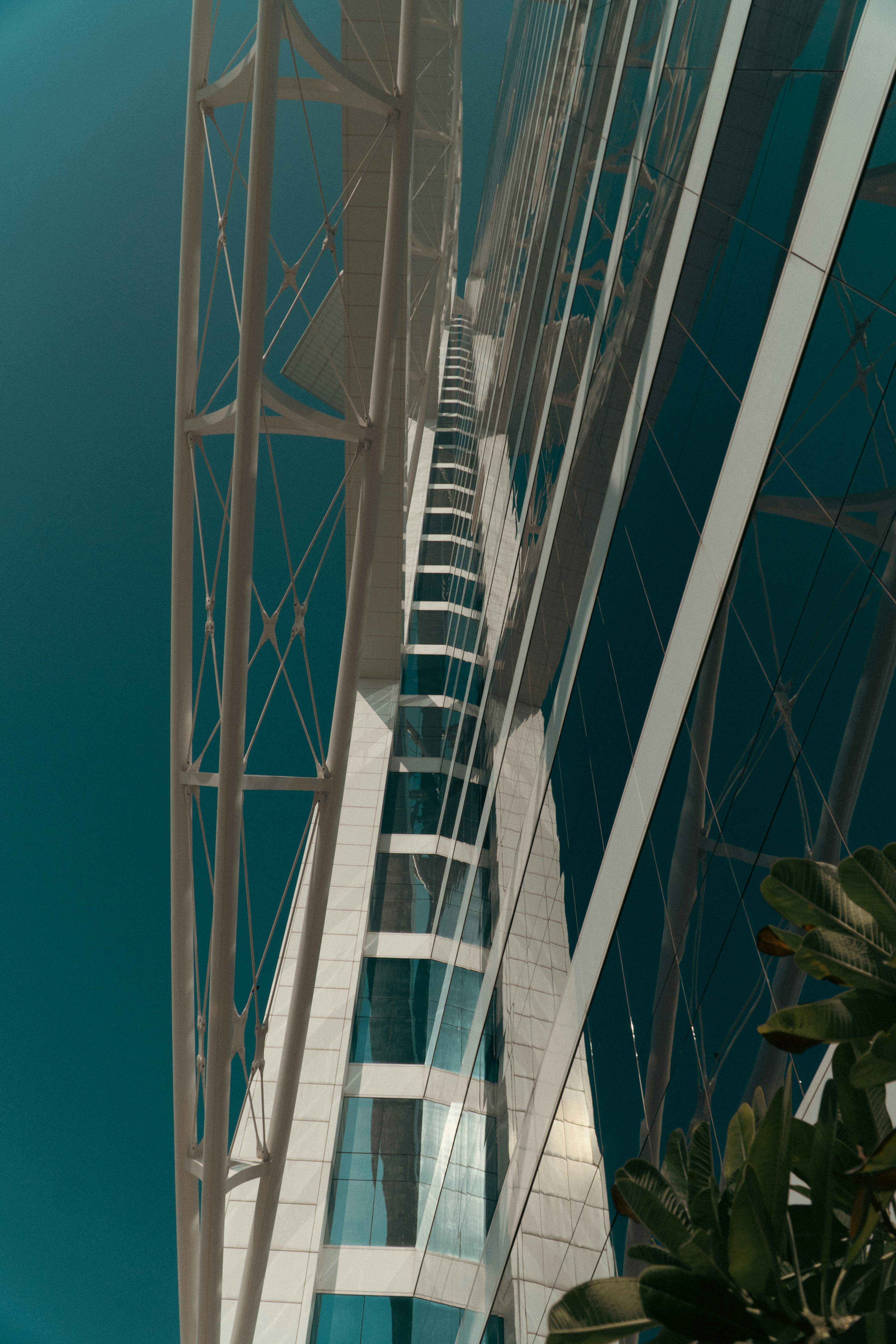 A very tall building with a very long glass window photo – Free ...