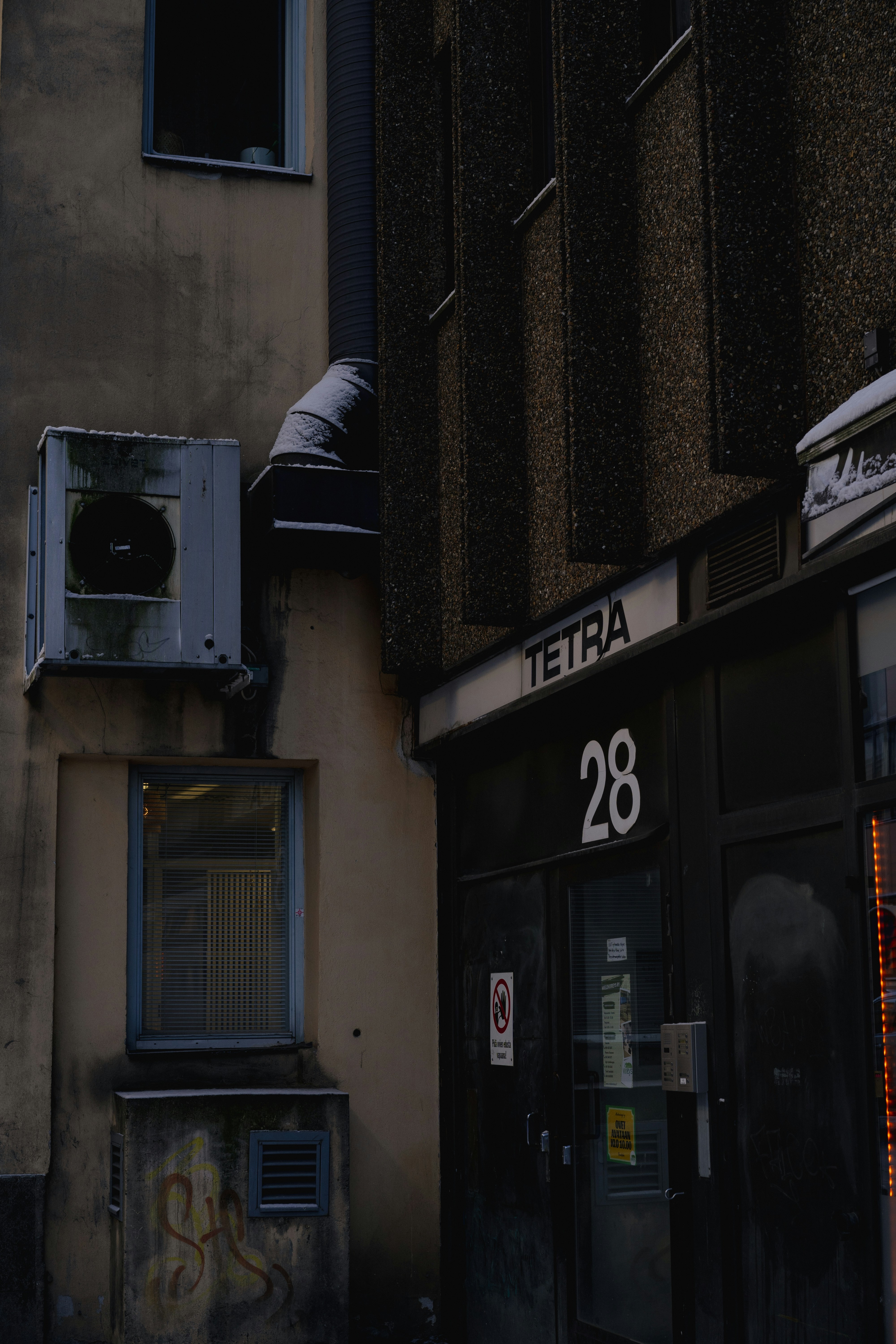 Doorway at 28 Under the TETRA Sign: A Nocturnal Urban Facade