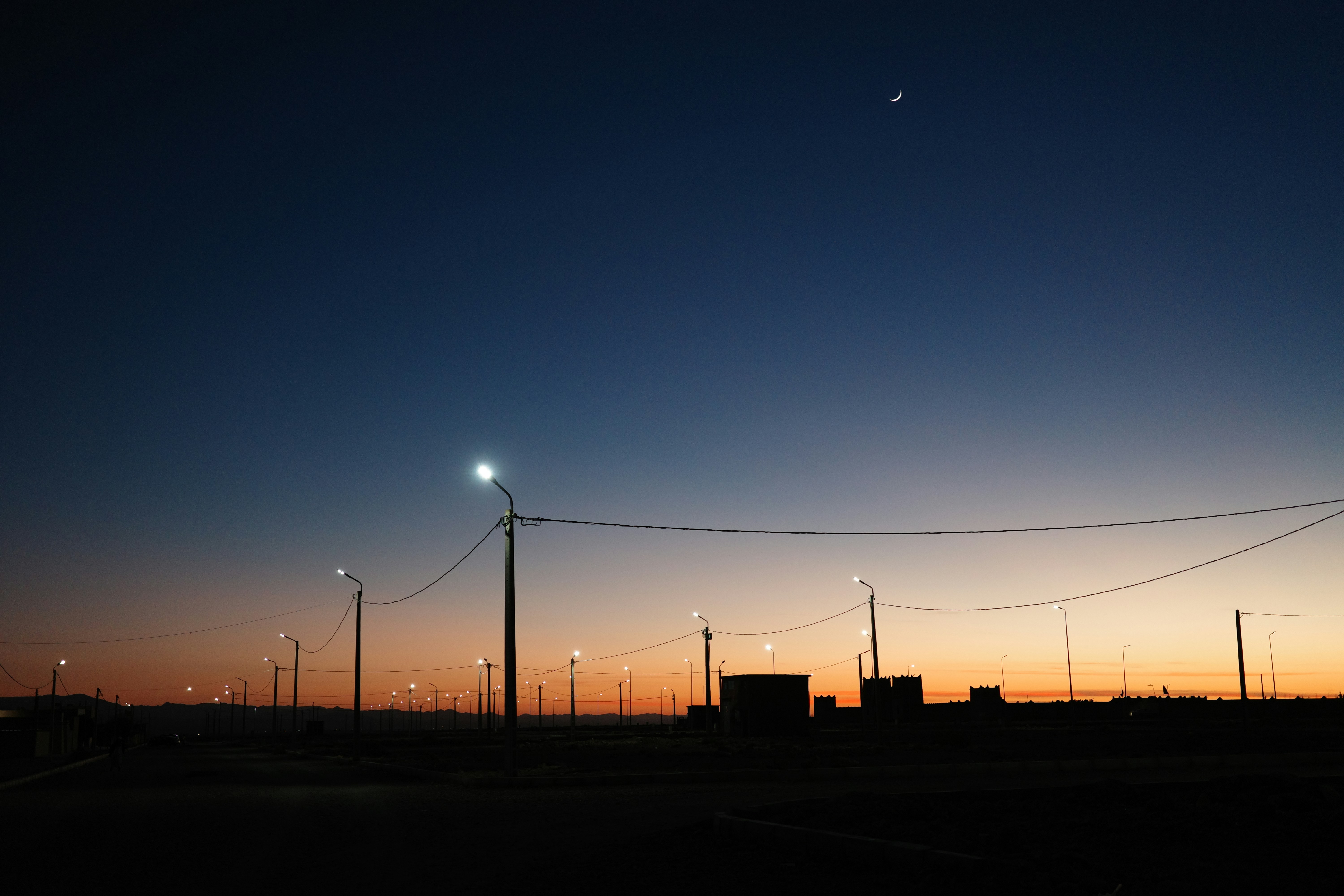 Lunar Luminescence Over Urban Silhouettes