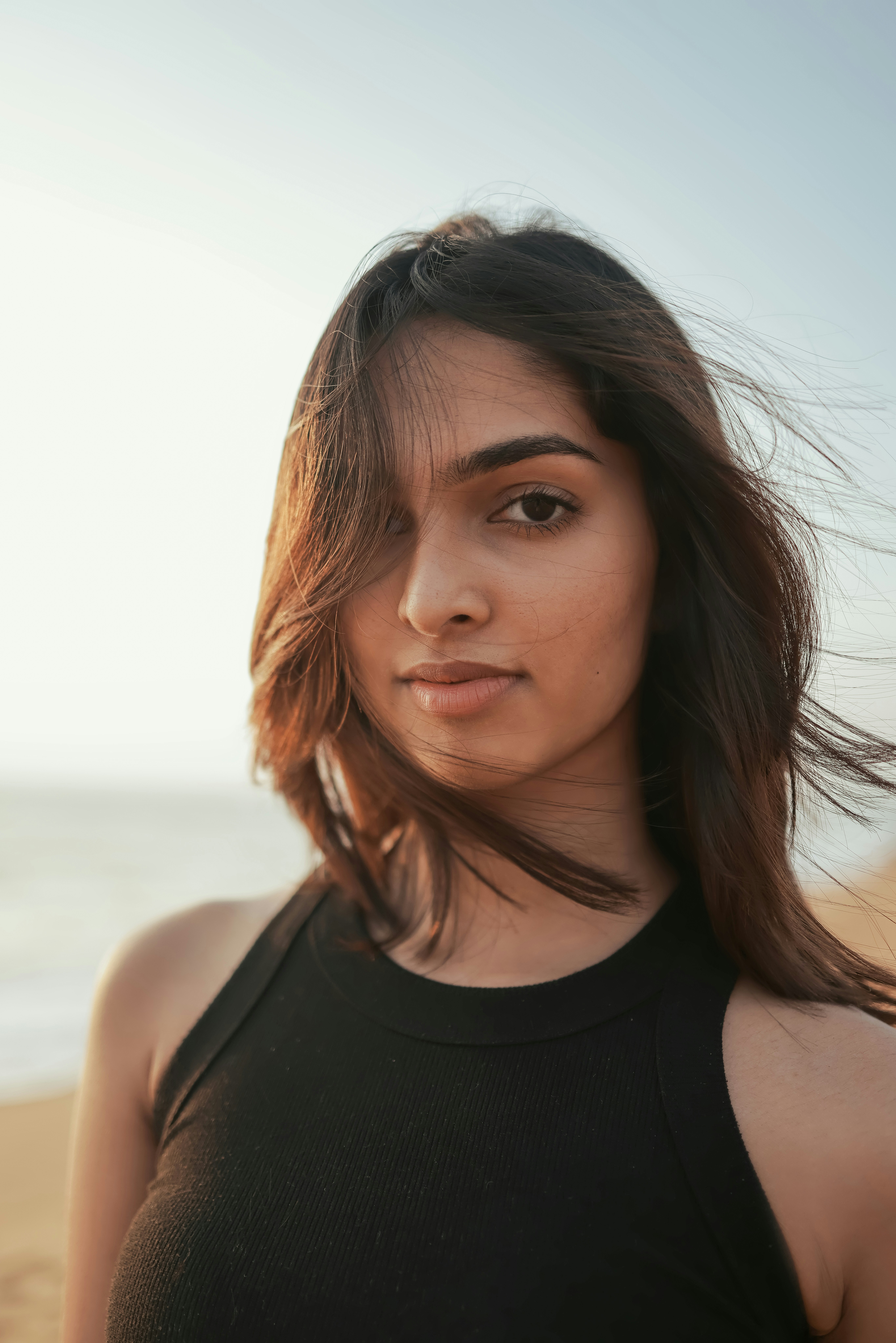 A beautiful young woman standing on top of a beach photo – Free Full hd wallpaper Image on Unsplash