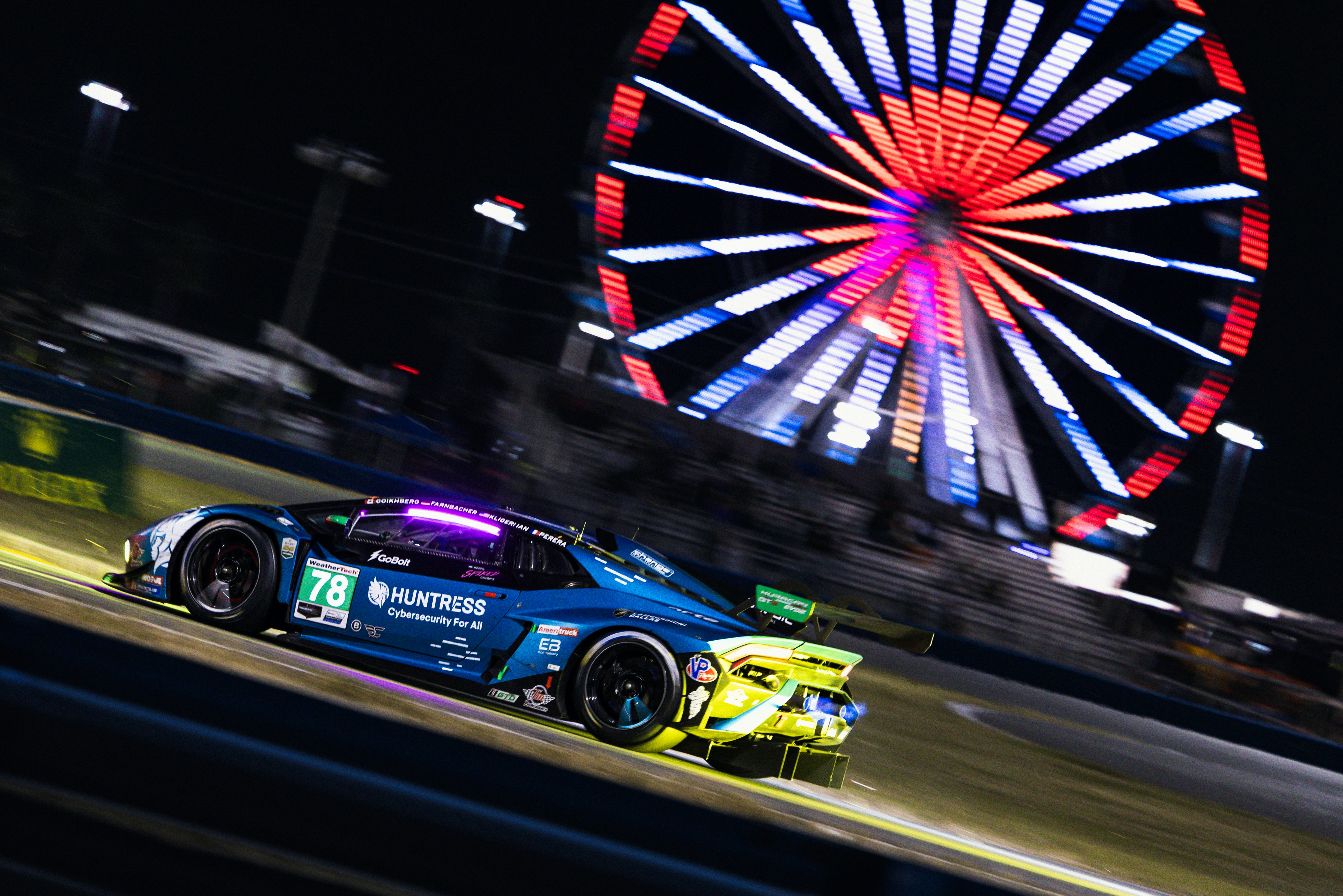 Blue-Yellow Racer in a Night Dash Beneath a Neon Ferris Wheel