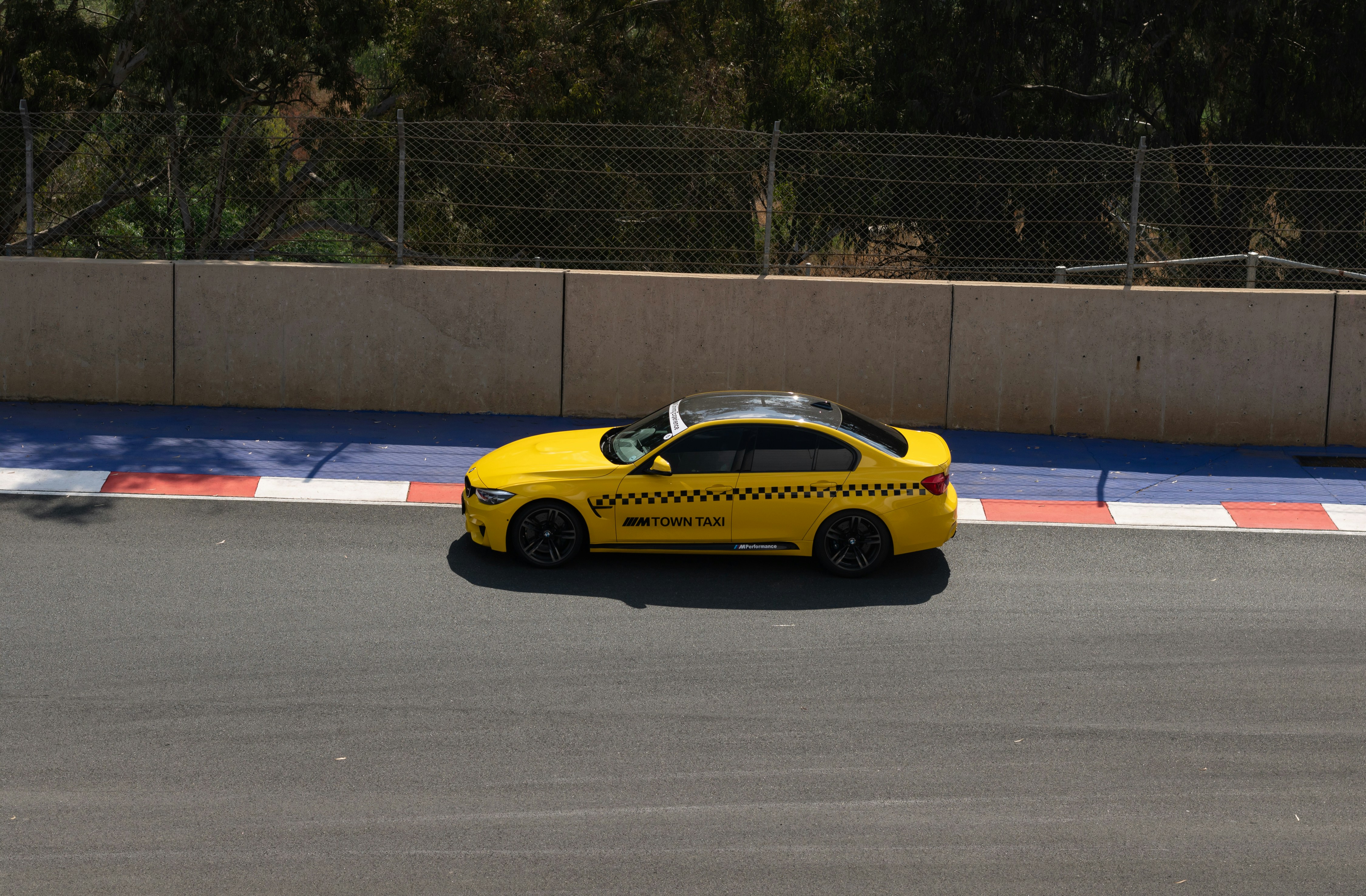 A yellow sports car driving down a race track photo – Free Kyalami park ...