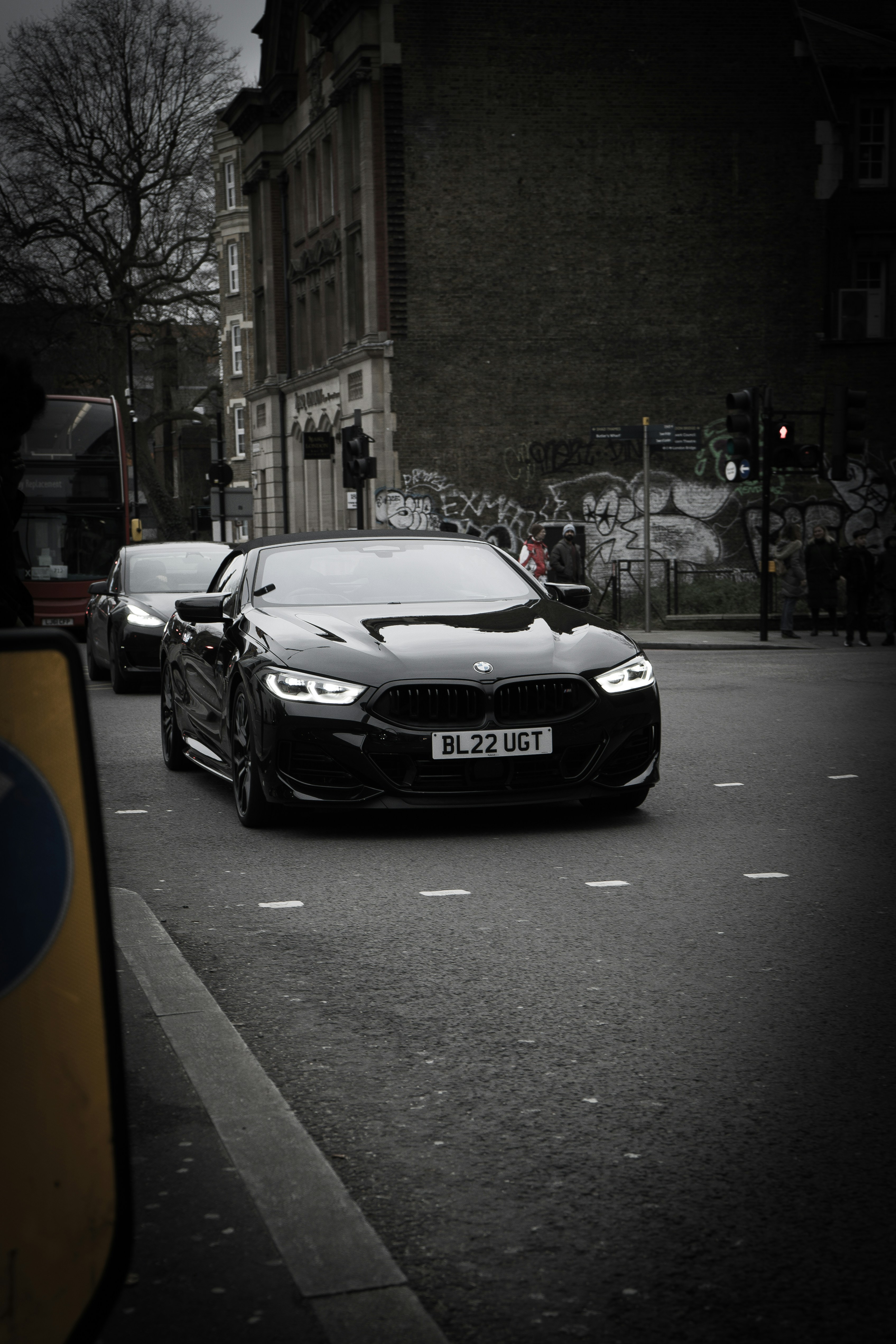 Monochrome Velocity: A BMW Races Through Graffiti-Laced City Streets