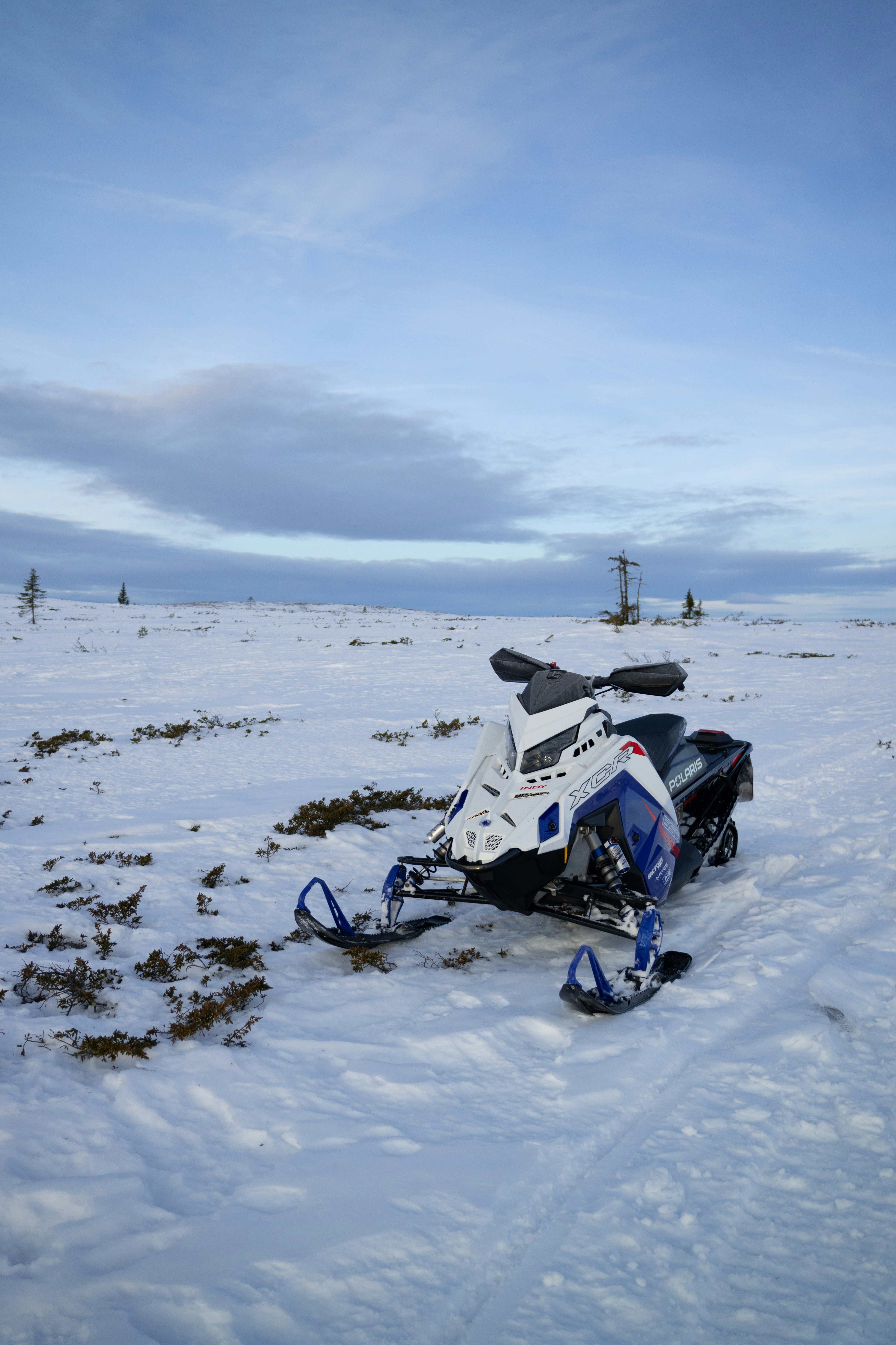 A snowmobile sitting in the middle of a snowy field photo – Free Norway ...