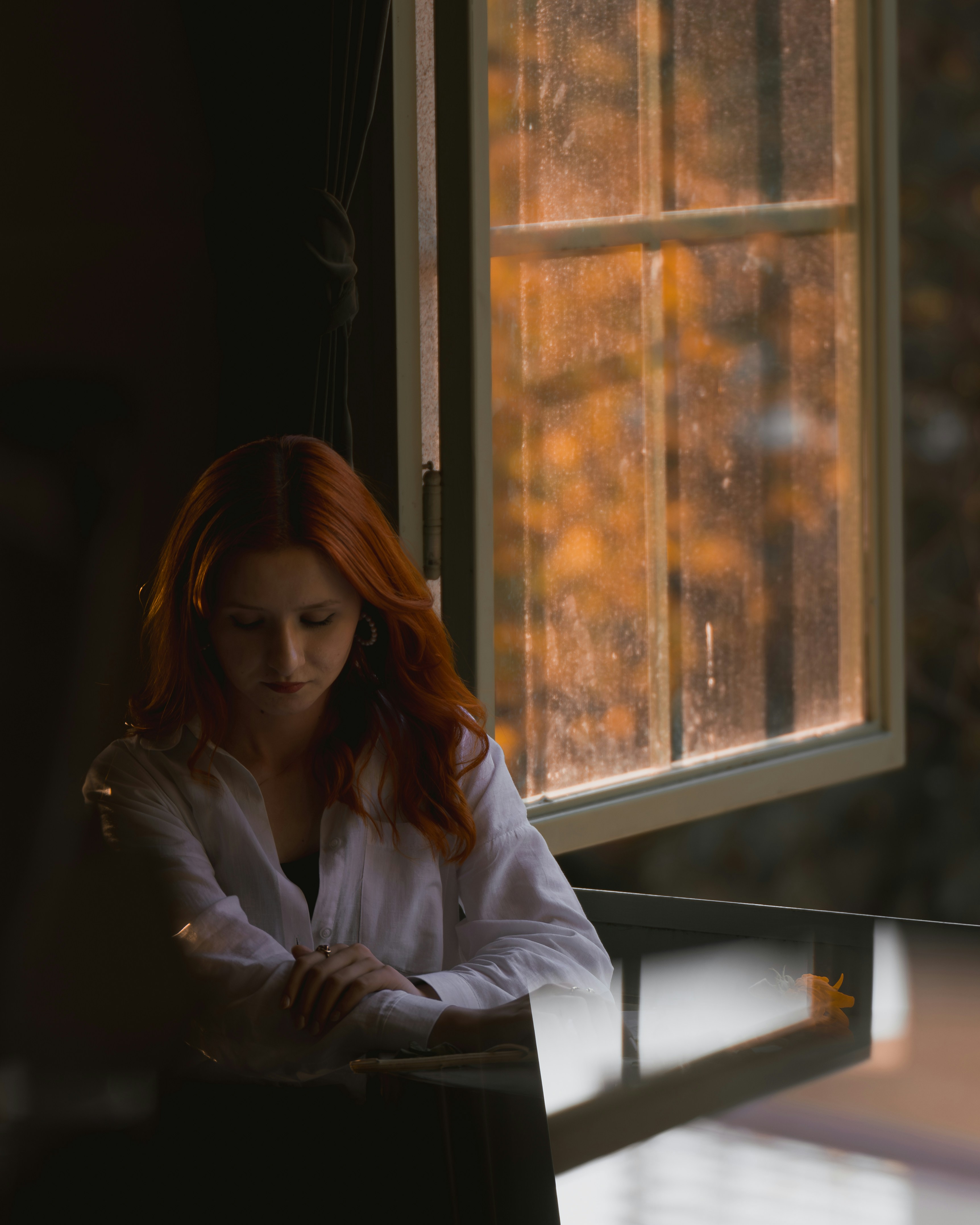Crimson Quiet by the Window: A Portrait Bathed in Soft Autumn Light
