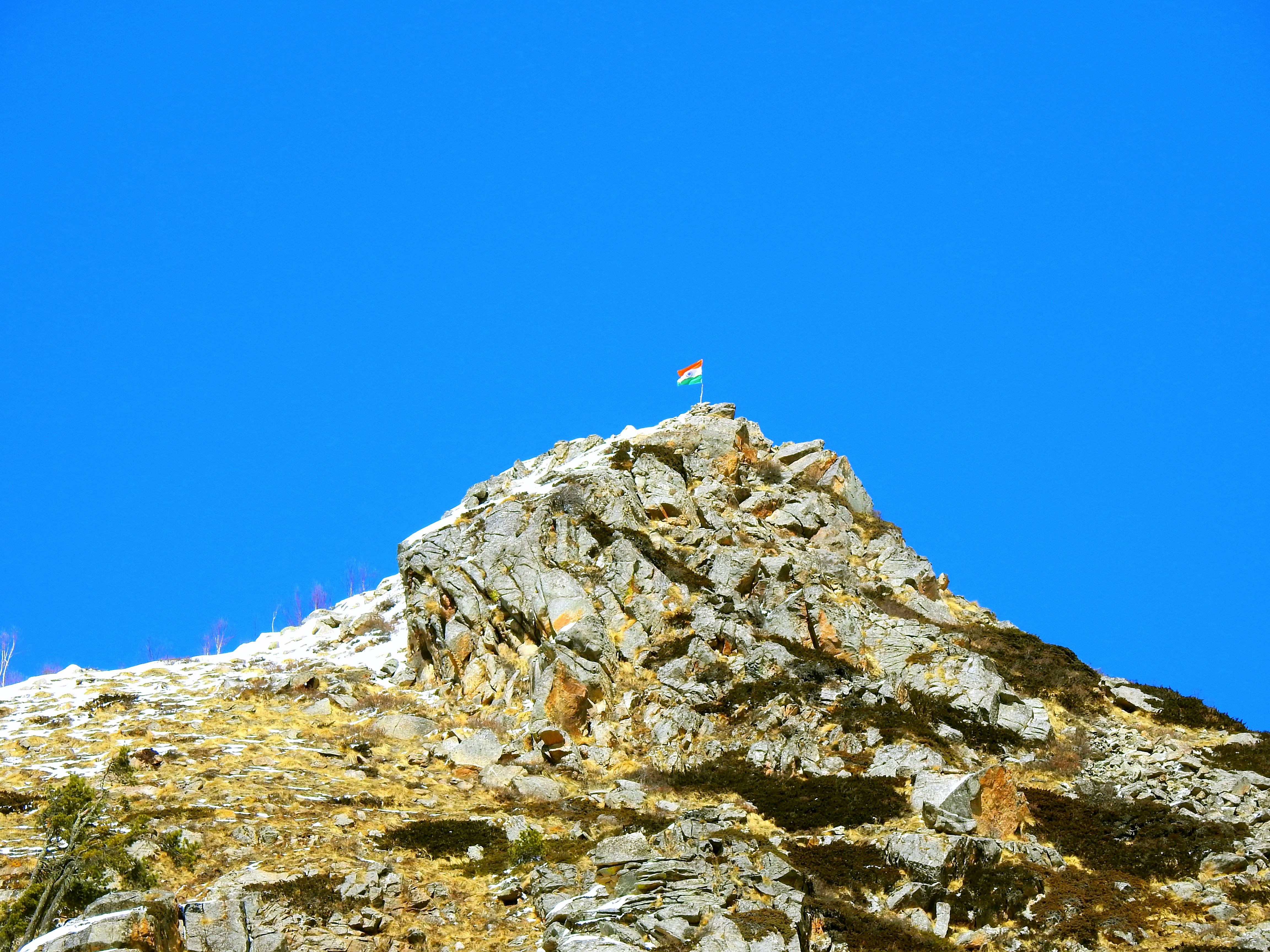 Summit of Serenity: Flag atop Rocky Heights