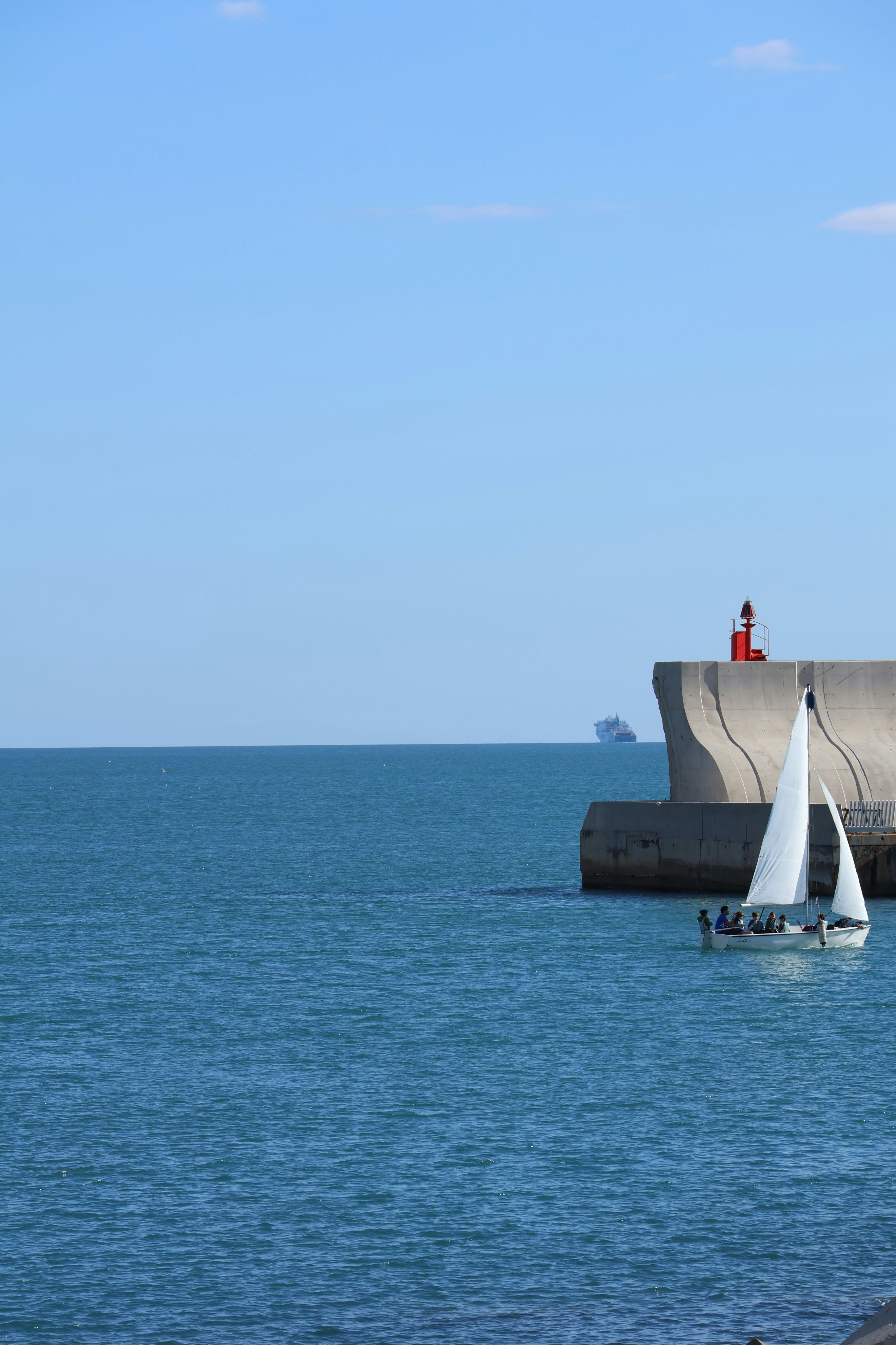 A couple of sail boats floating on top of a body of water photo – Free ...
