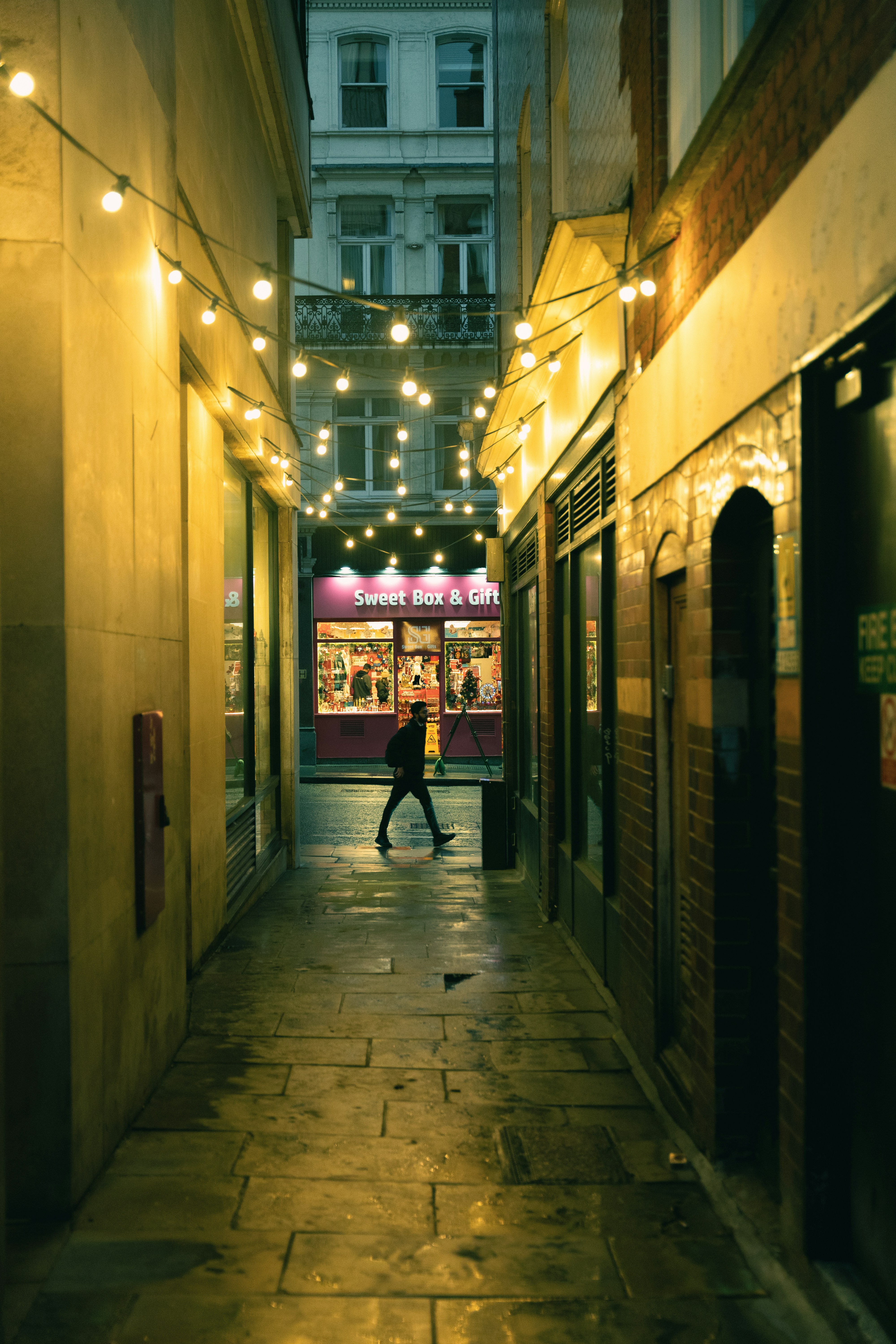 A person walking down an alley way at night photo – Free 24 ludgate ...