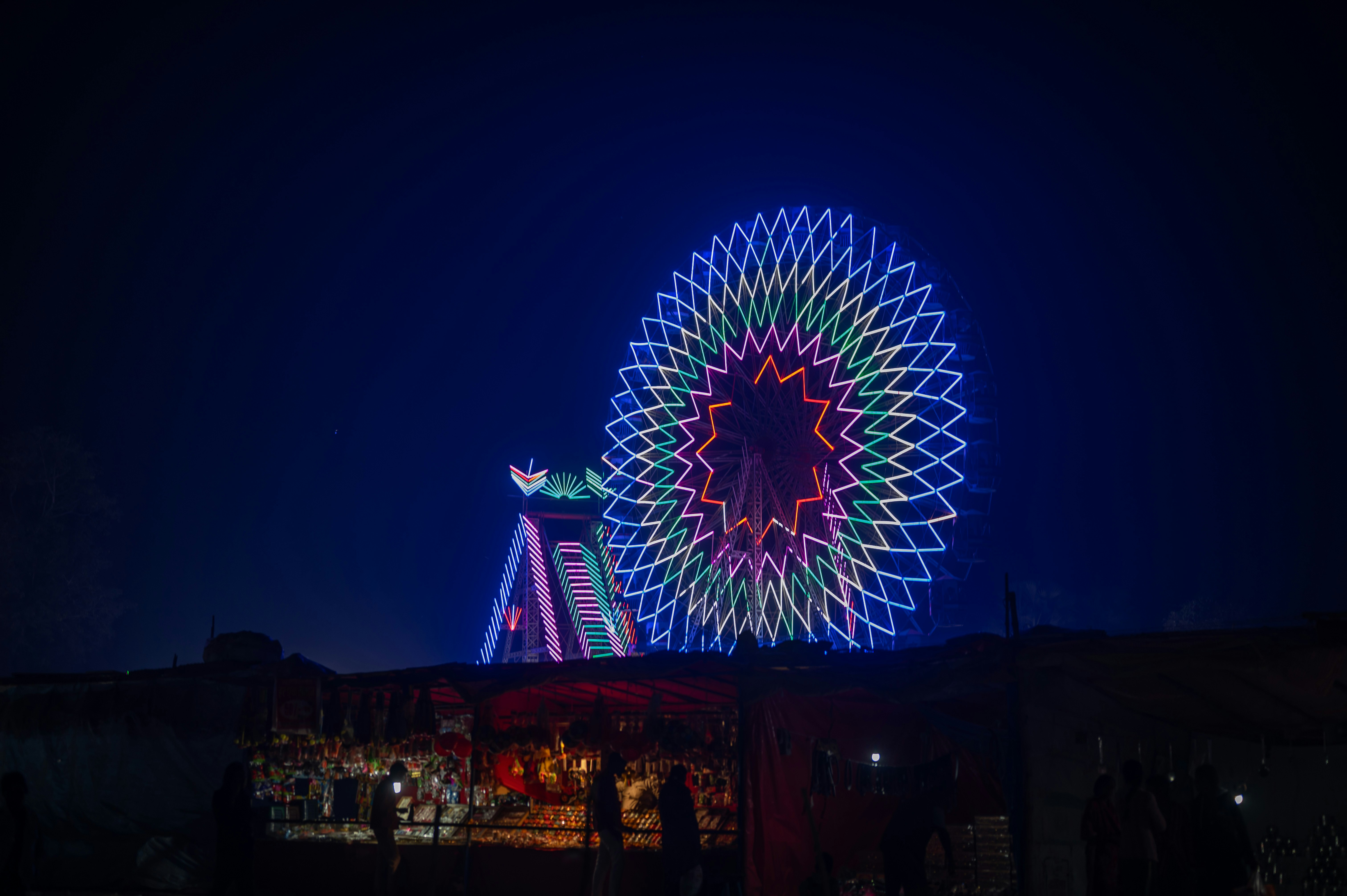 Neon Bloom Over a Night Market: The Ferris Wheel Lights the Evening