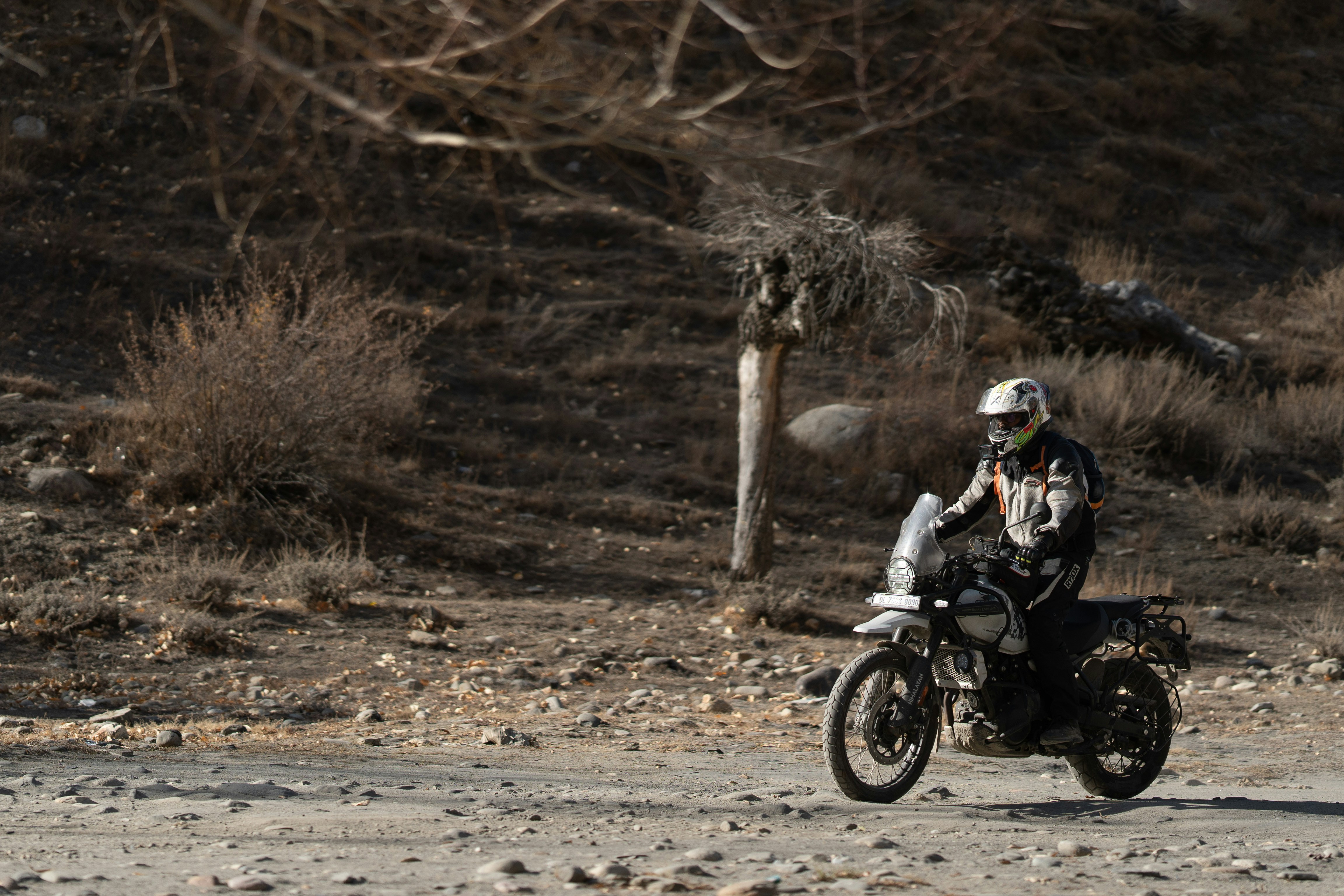 Rugged Ride: A Solo Rider Traverses a Deserted Terrain