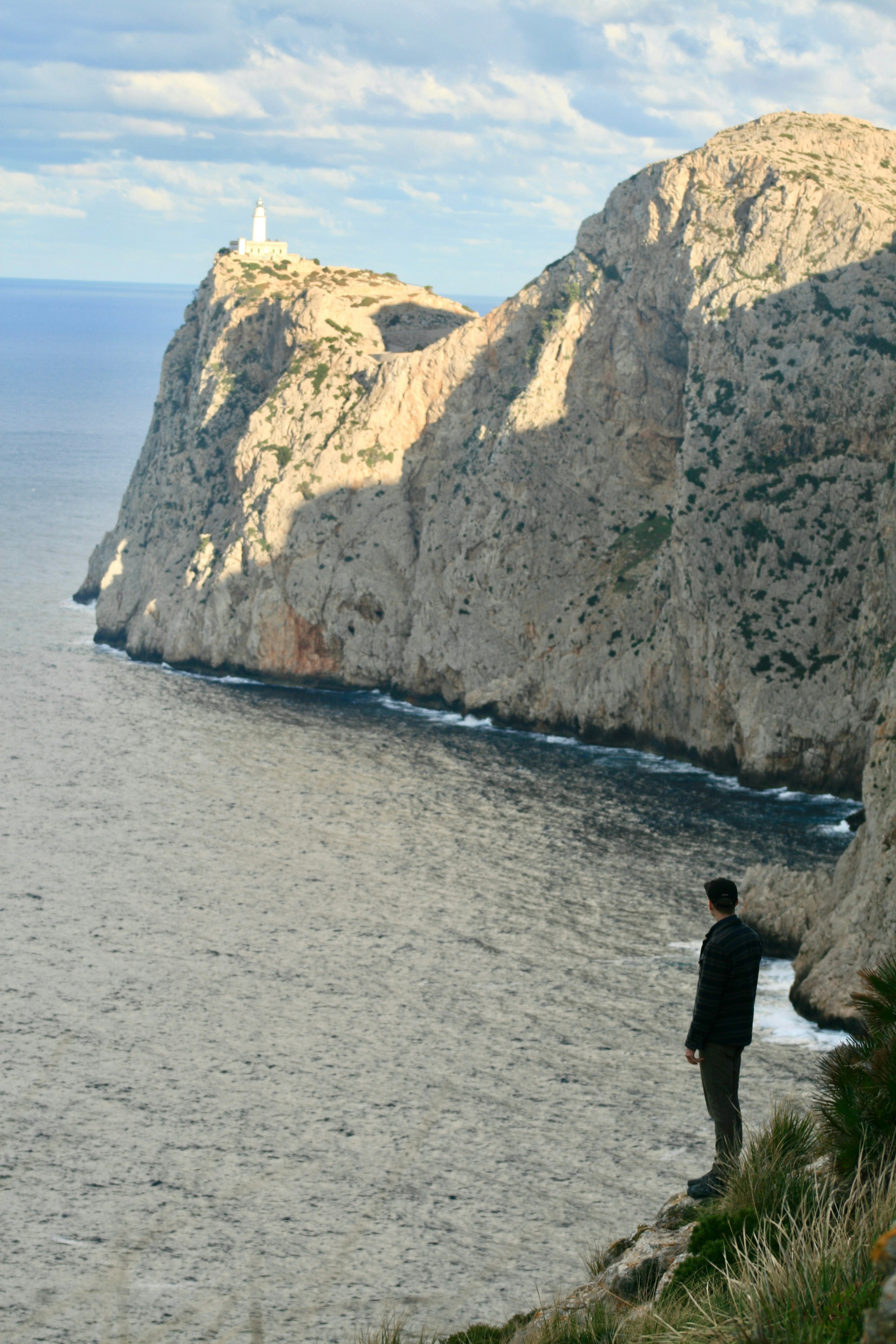 Cliffside Watcher: A Figure at the Edge of the Sea