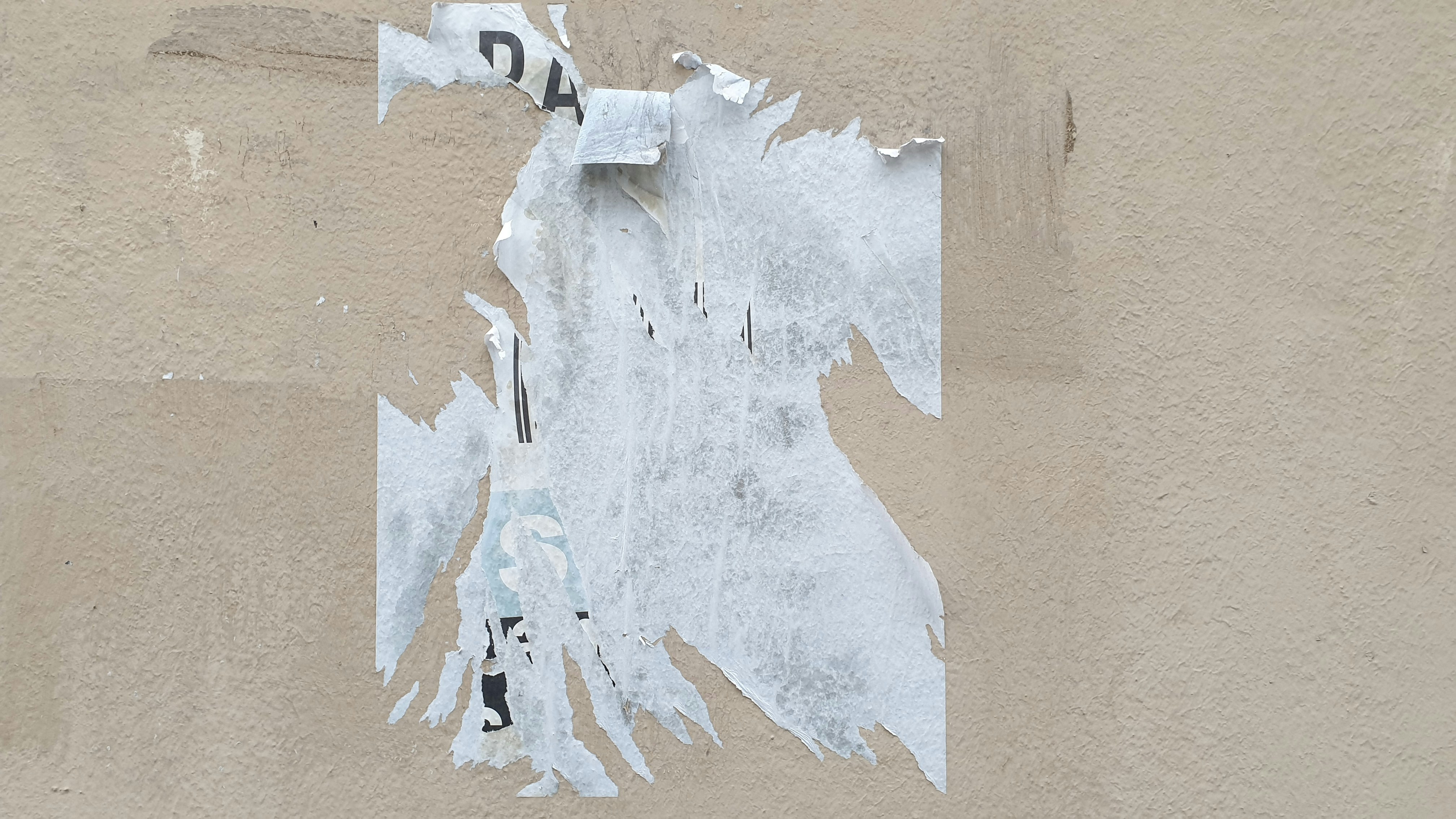 A picture of a piece of paper taped to the side of a building photo ...