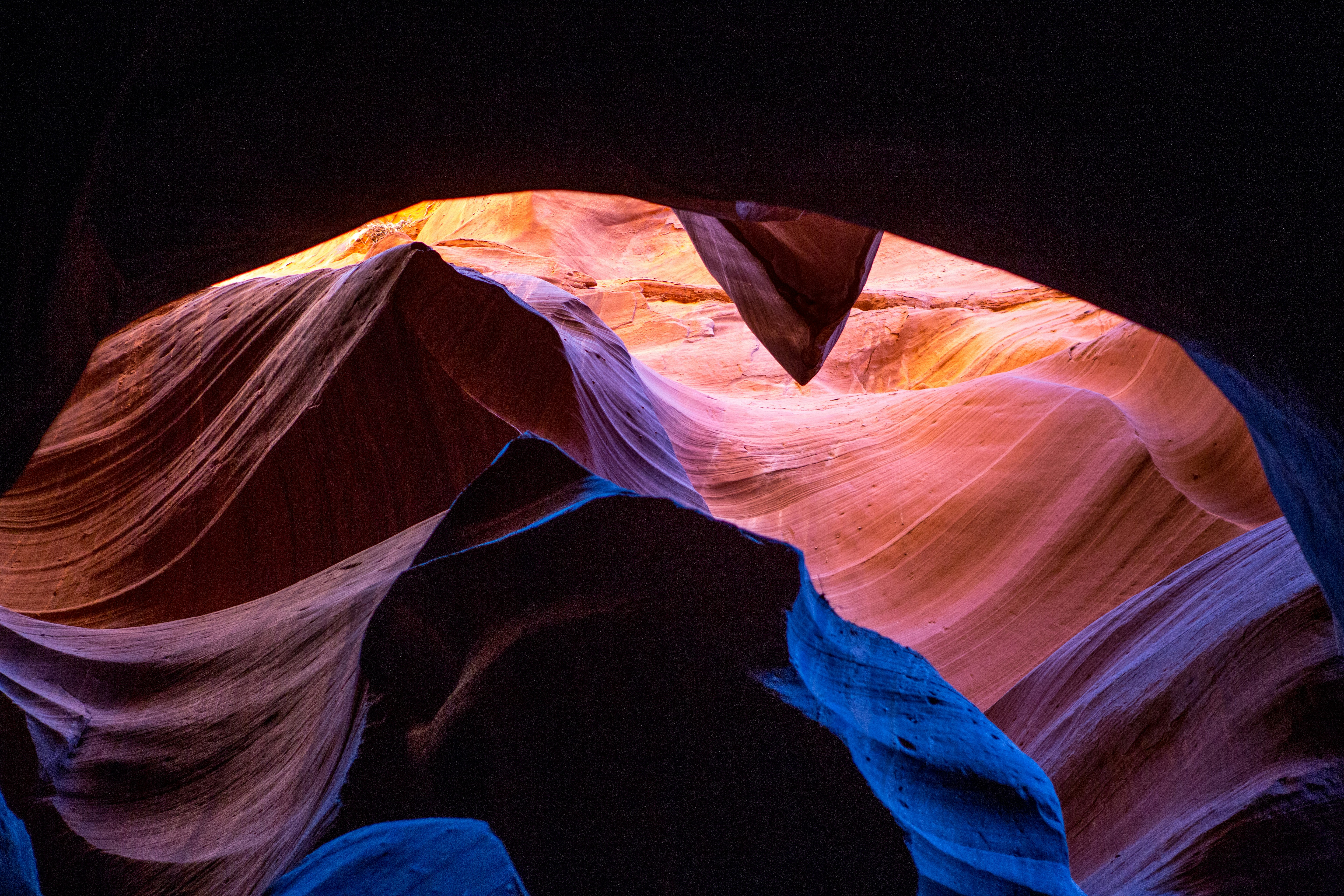 Sunlit Ribbons in a Slot Canyon: Warm Coral Peaks Meet Blue Shadows