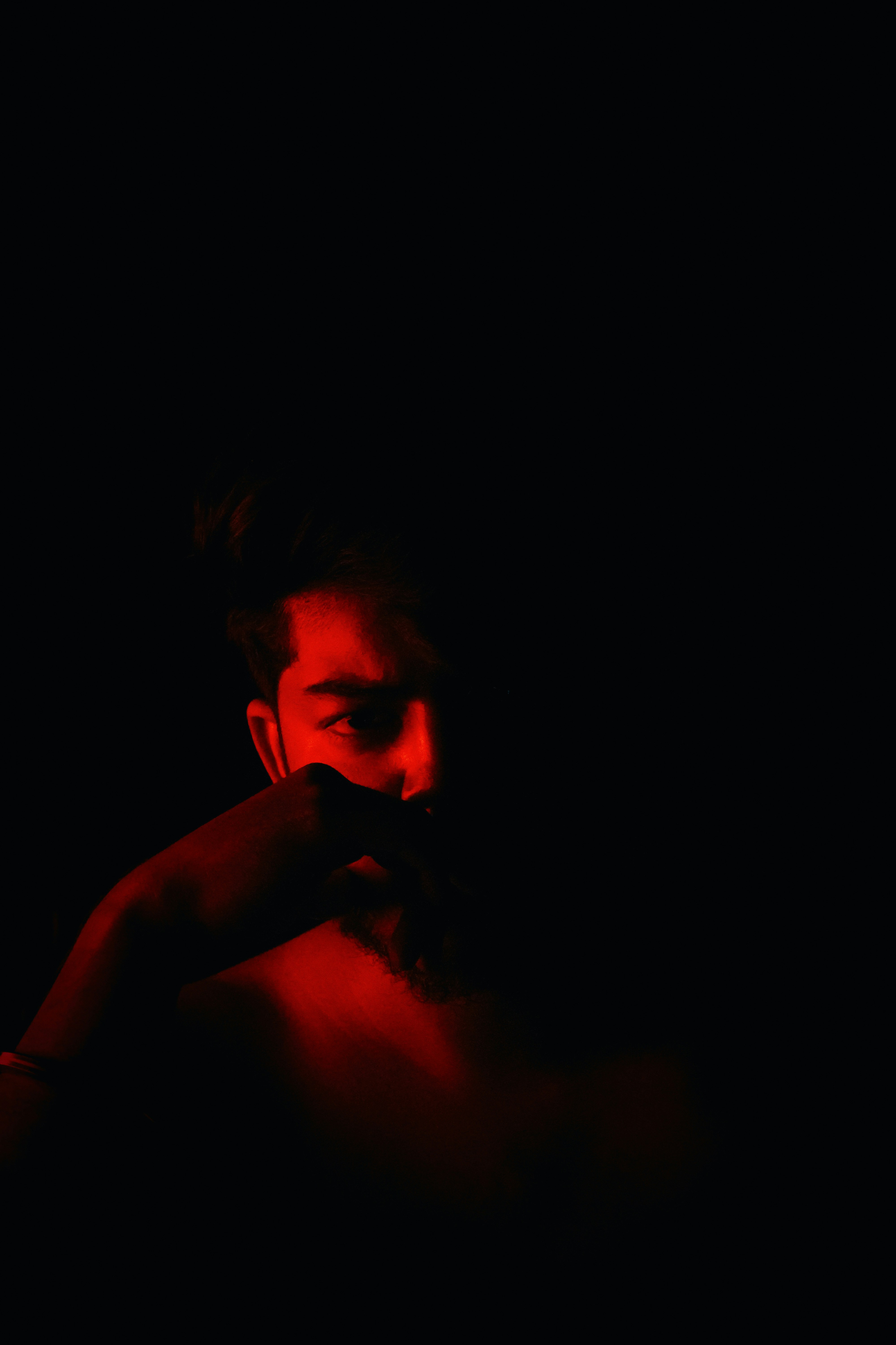 Crimson Quiet: A Portrait Carved by Red Light in Deep Shadow