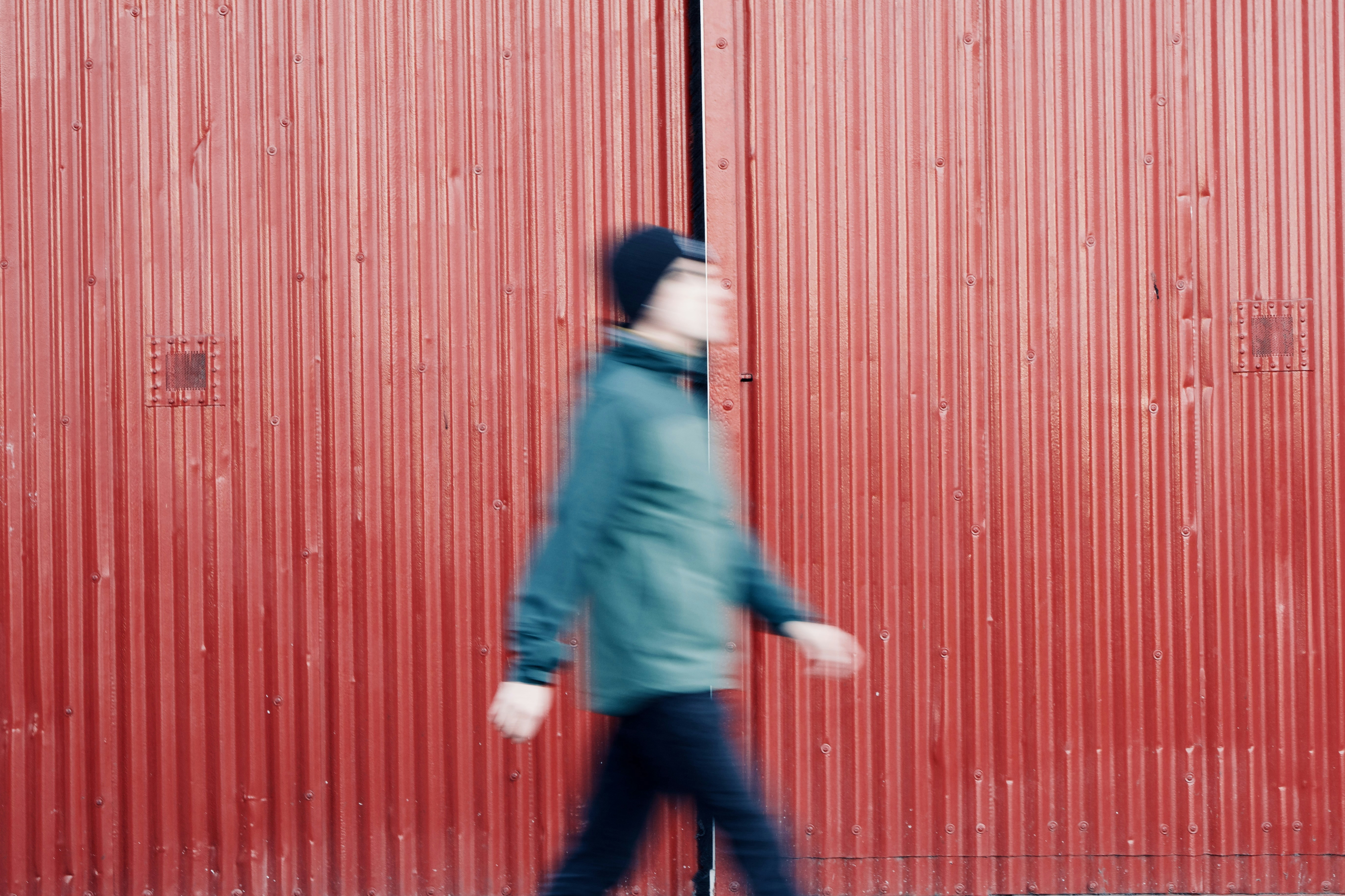 Teal in Motion Against Urban Red
