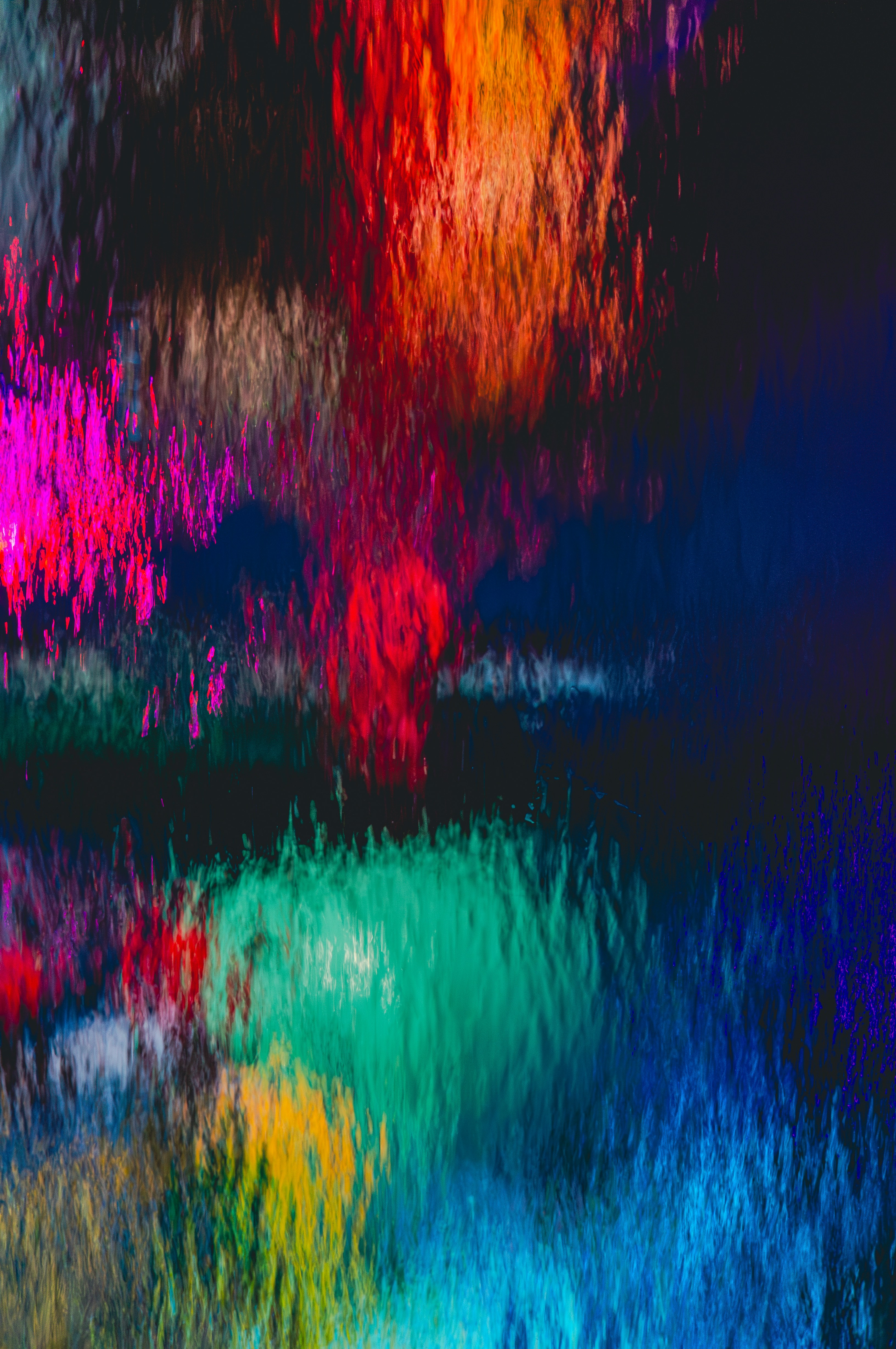 Abstract display of vivid colors resembling a blurred cityscape reflection.