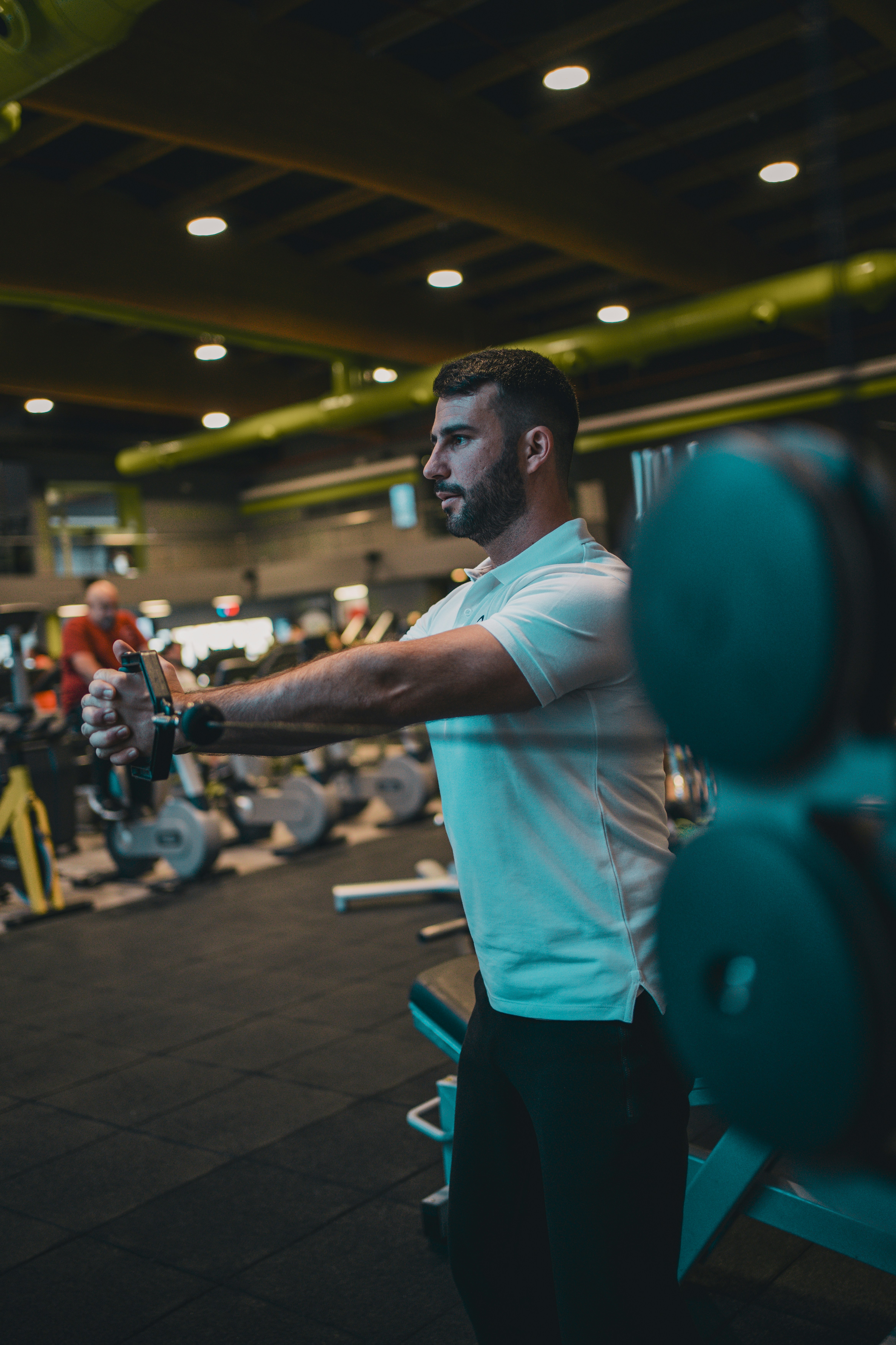 A man in a gym holding a barbell photo – Free Man Image on Unsplash