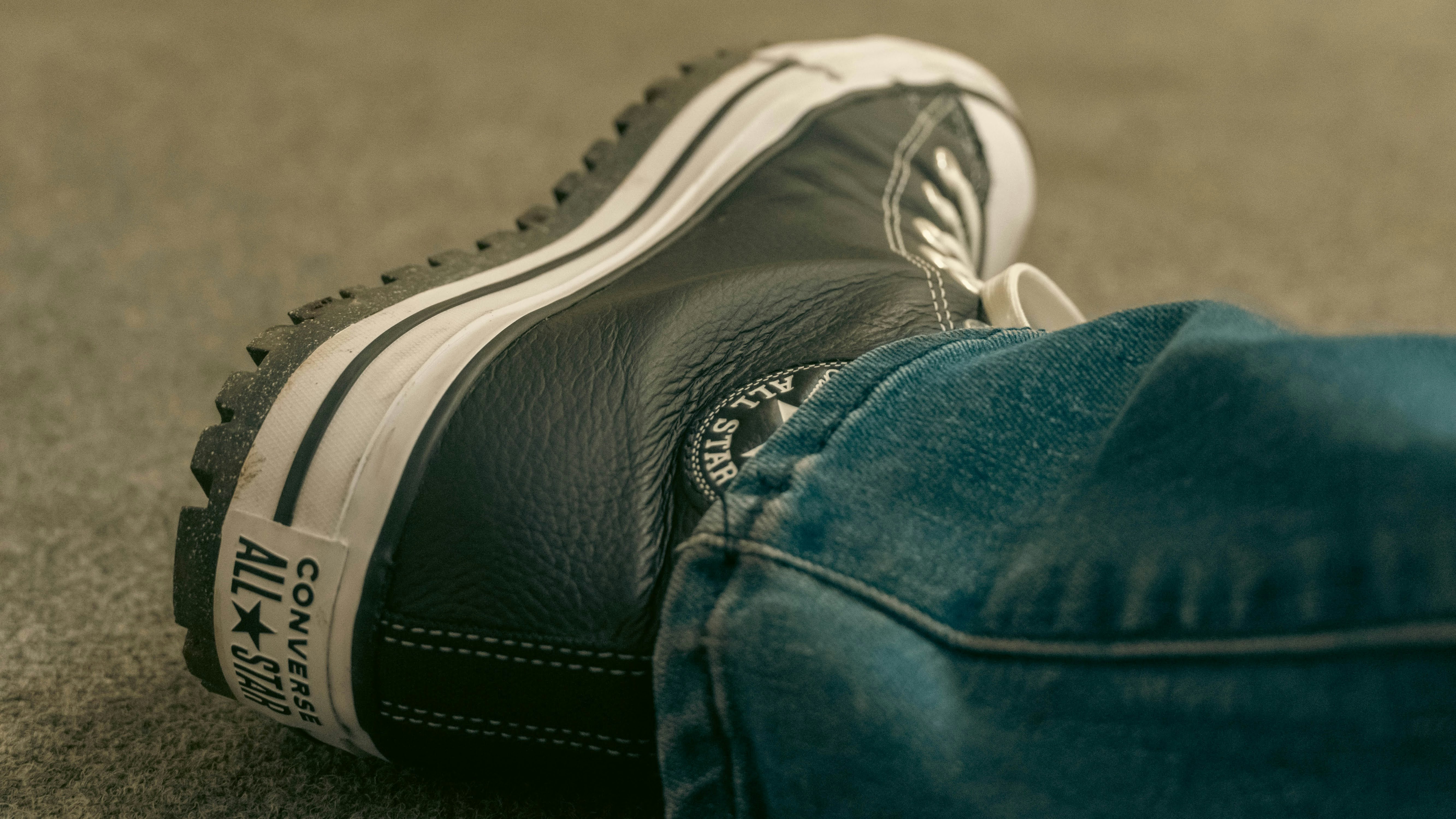 A pair of shoes that are on the ground photo – Free Sneakers Image on ...