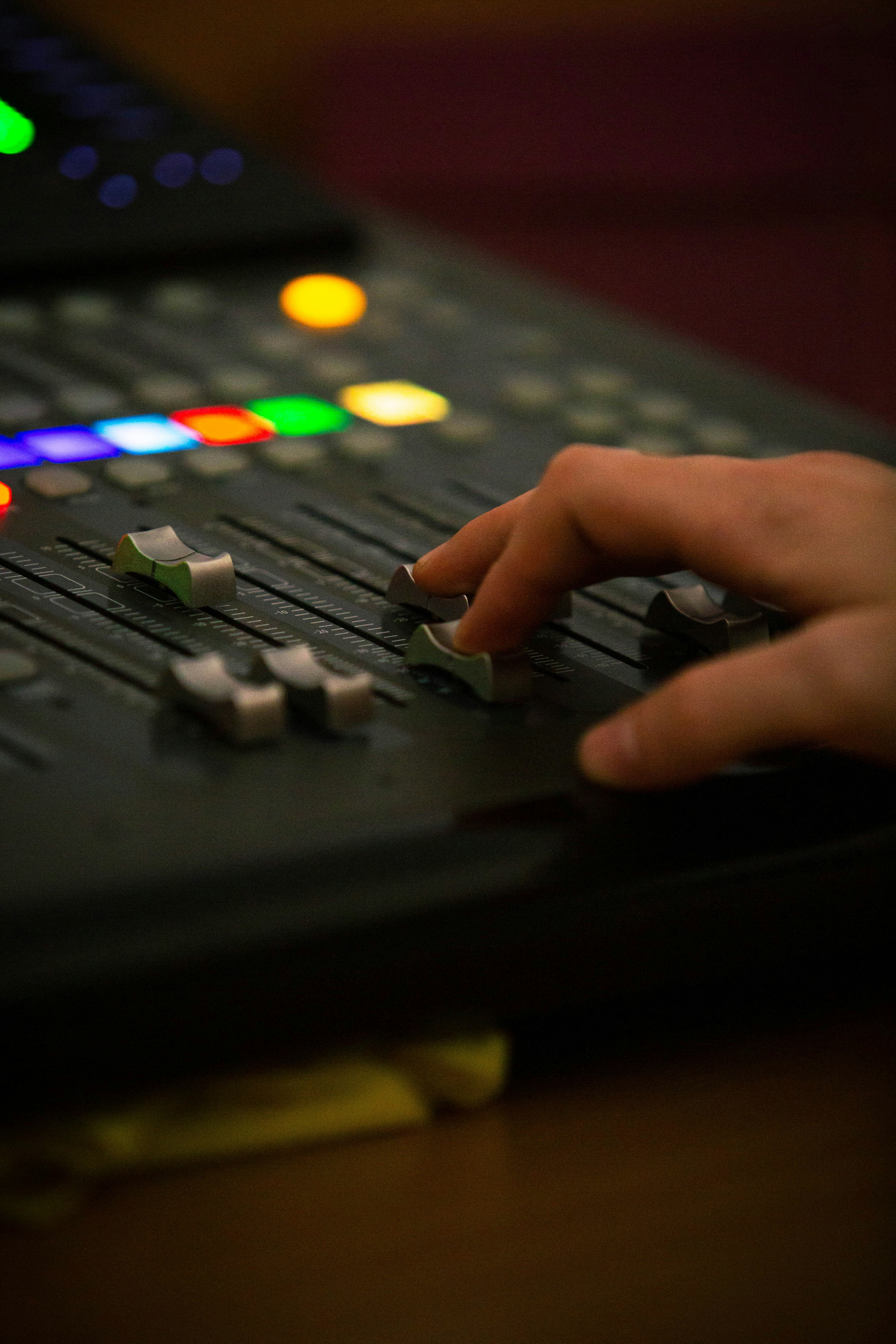 A person is pressing buttons on a sound board photo – Free Indoors ...