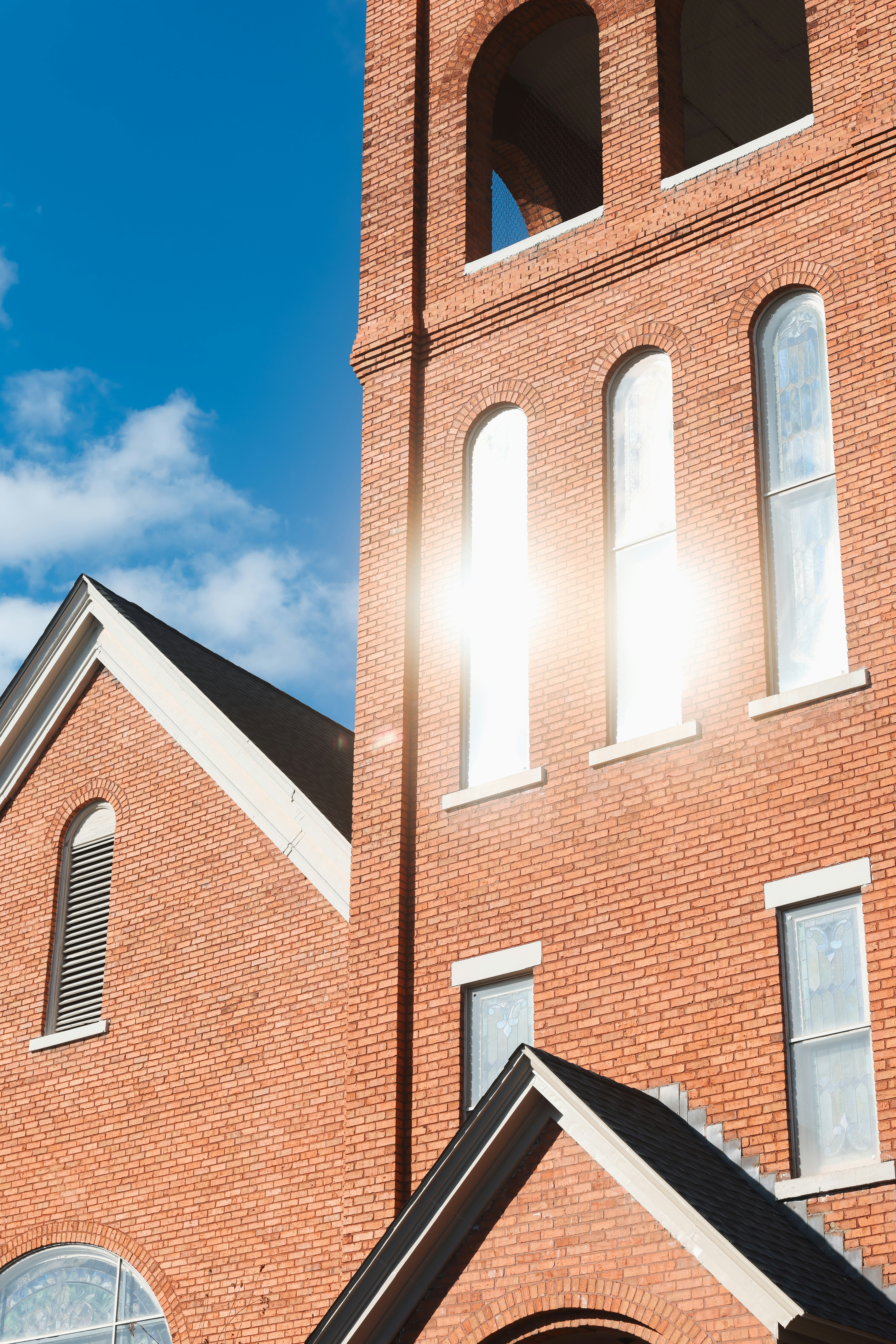 A large brick church with a clock tower photo – Free Building Image on ...