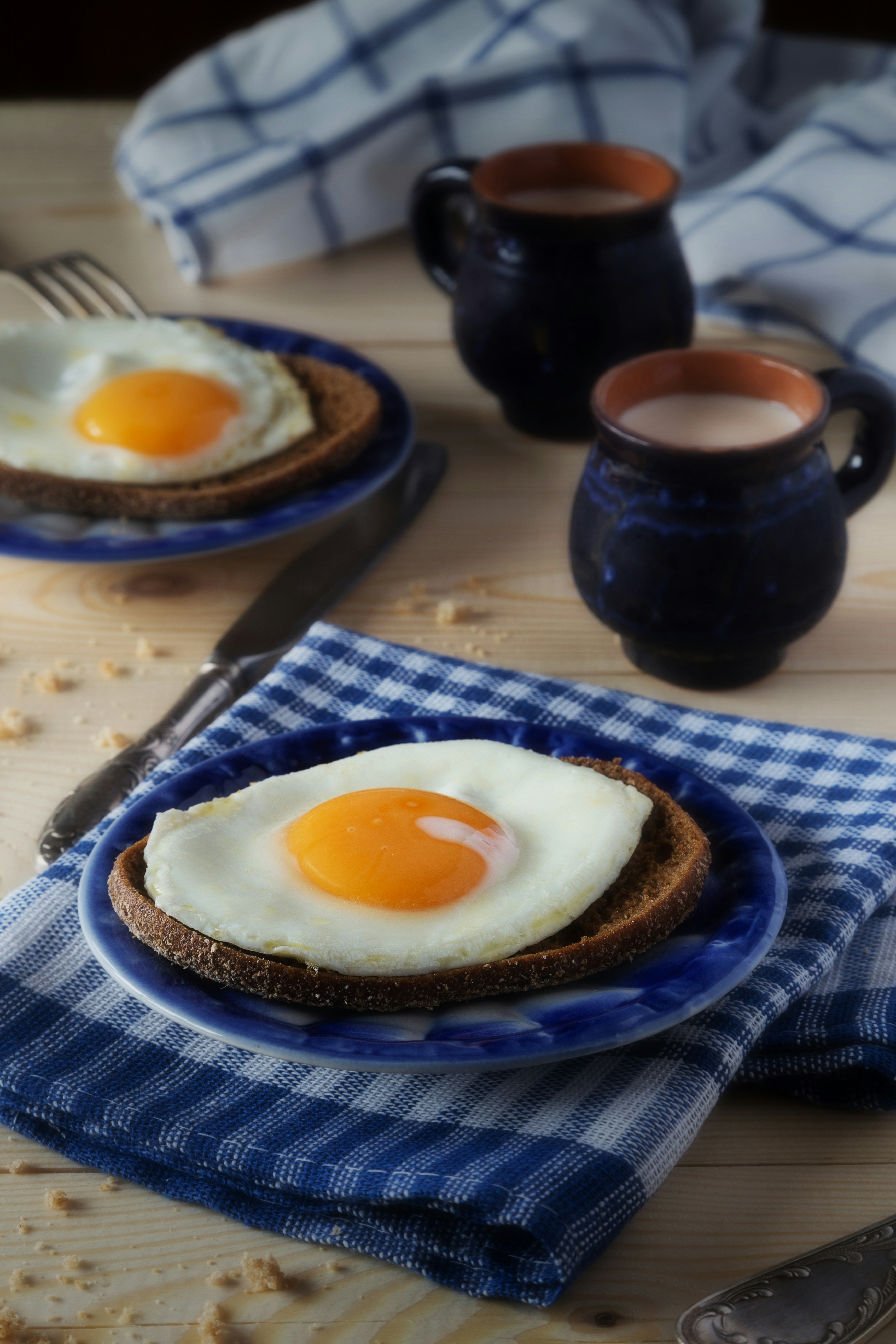 Cerulean Breakfast: Sunny Egg on Toast Amid Blue Ceramics
