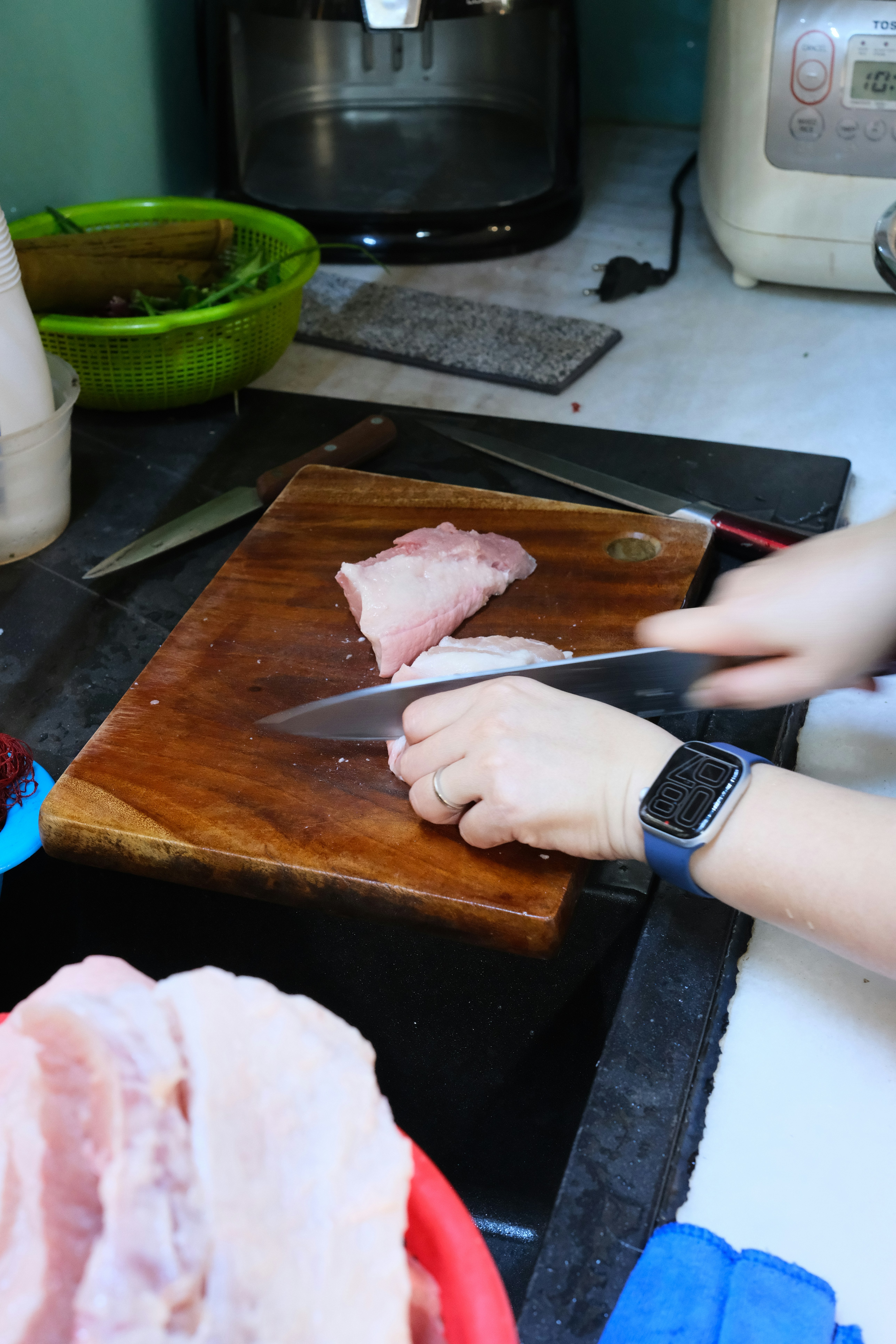 Precise Cut: Quiet Focus on Knife and Pork on a Wooden Cutting Board