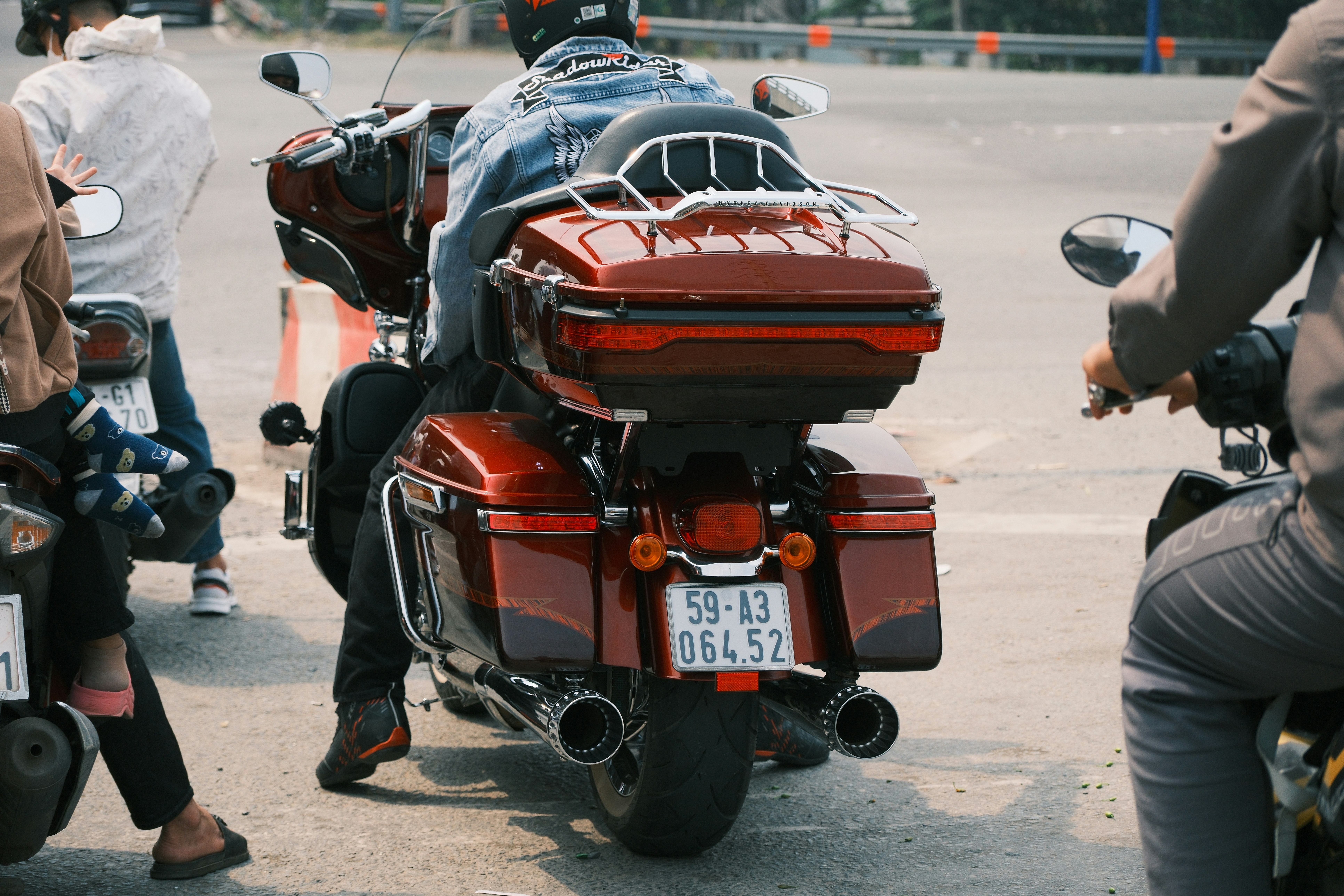 A group of people riding motorcycles down a street photo – Free Man ...
