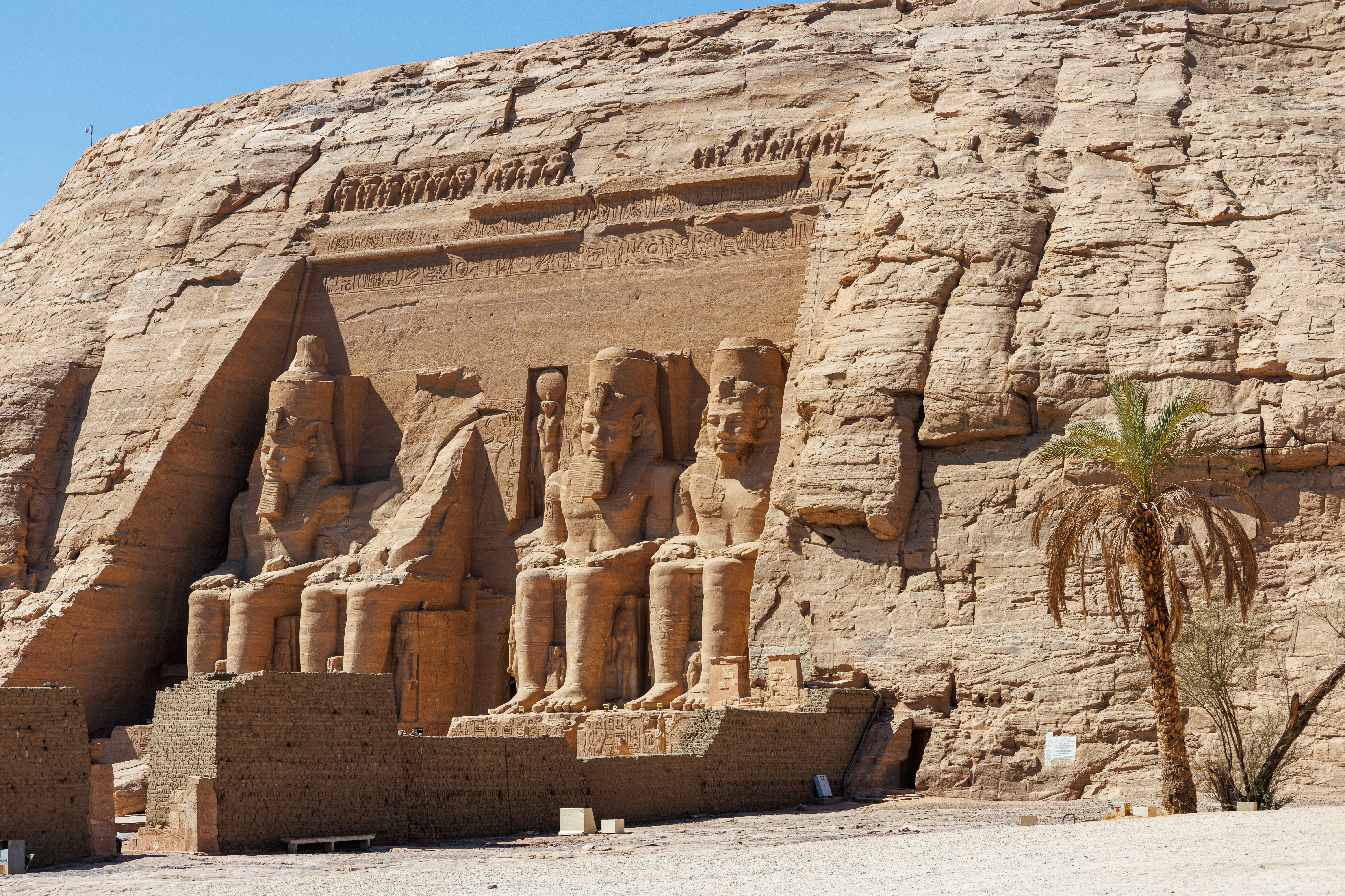 A large stone structure with statues on the side of it photo – Free ...