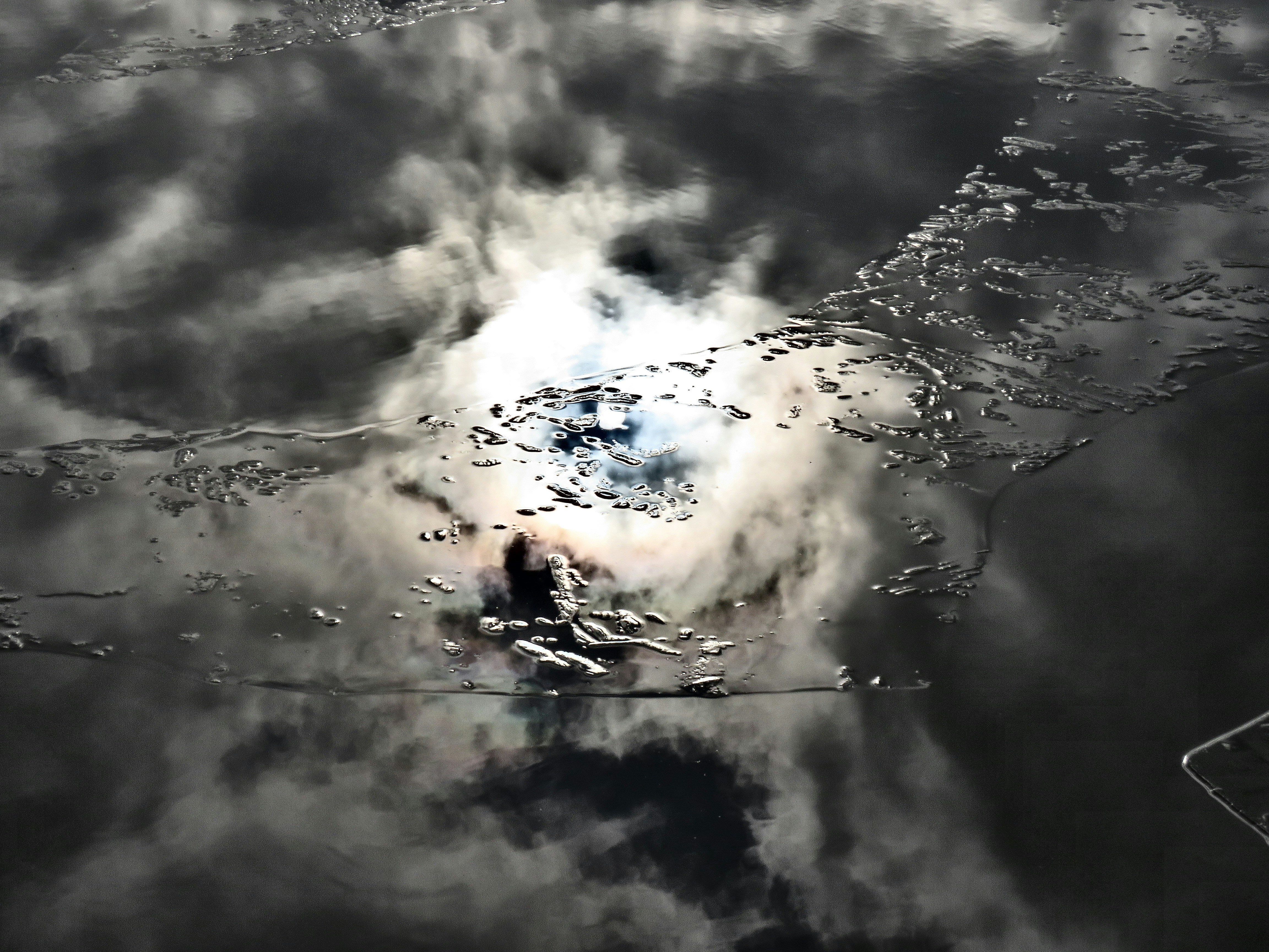 An aerial view of a cloudy sky with a circular object in the center ...