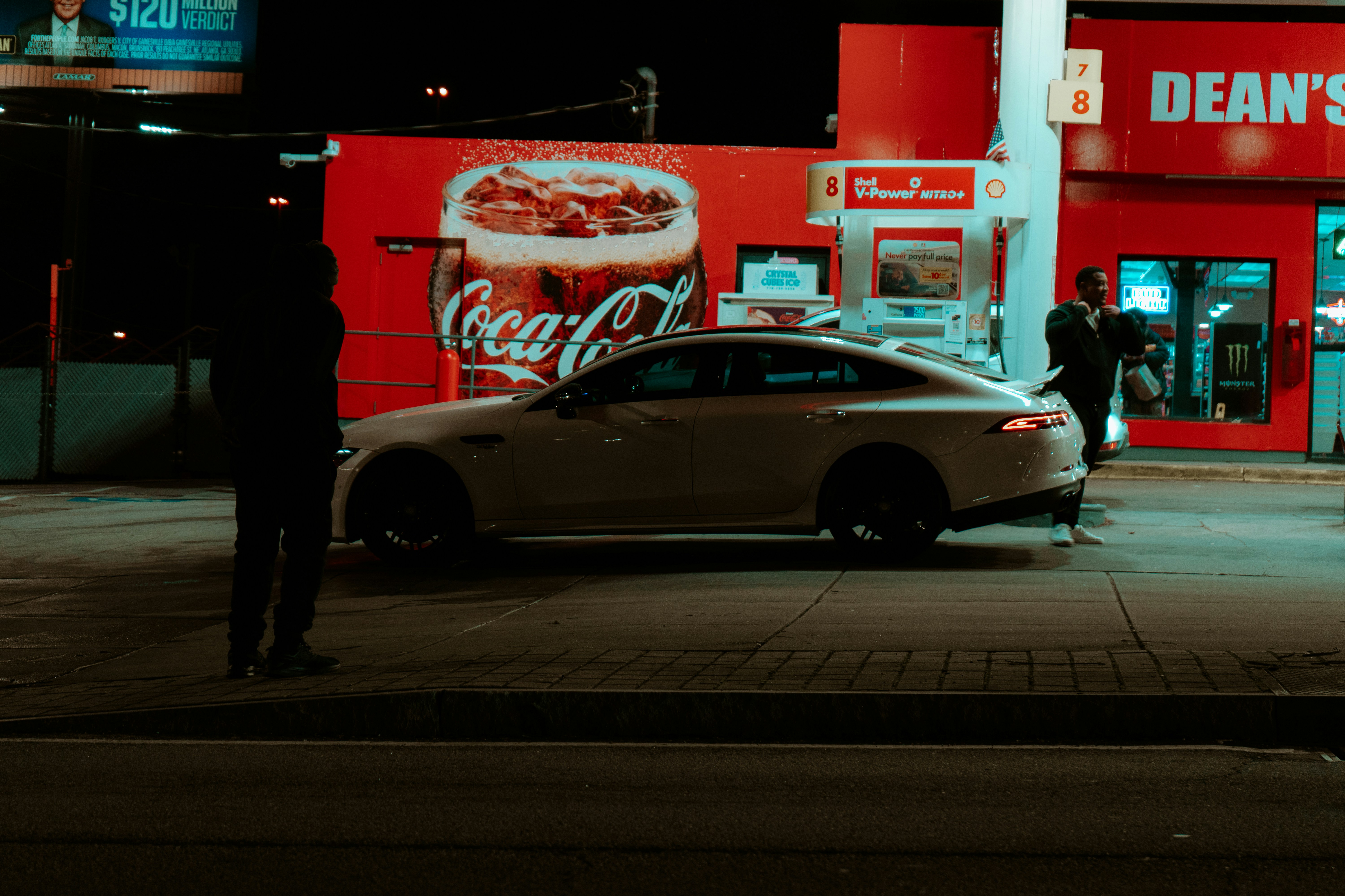 Midnight Sedan Beneath Neon Coca-Cola: A Quiet Street Portrait