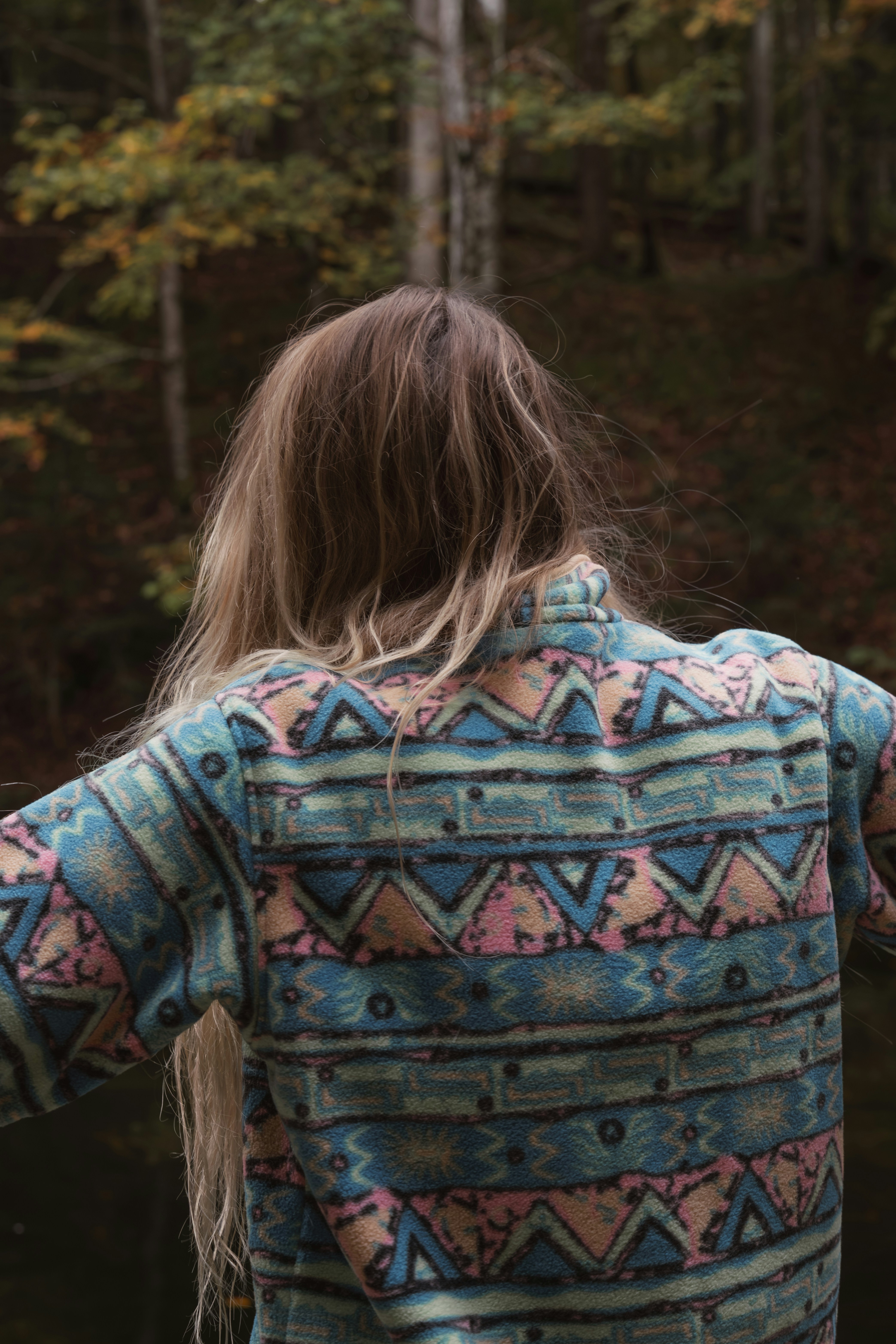 Backlit Jacketed Figure in Autumn Forest
