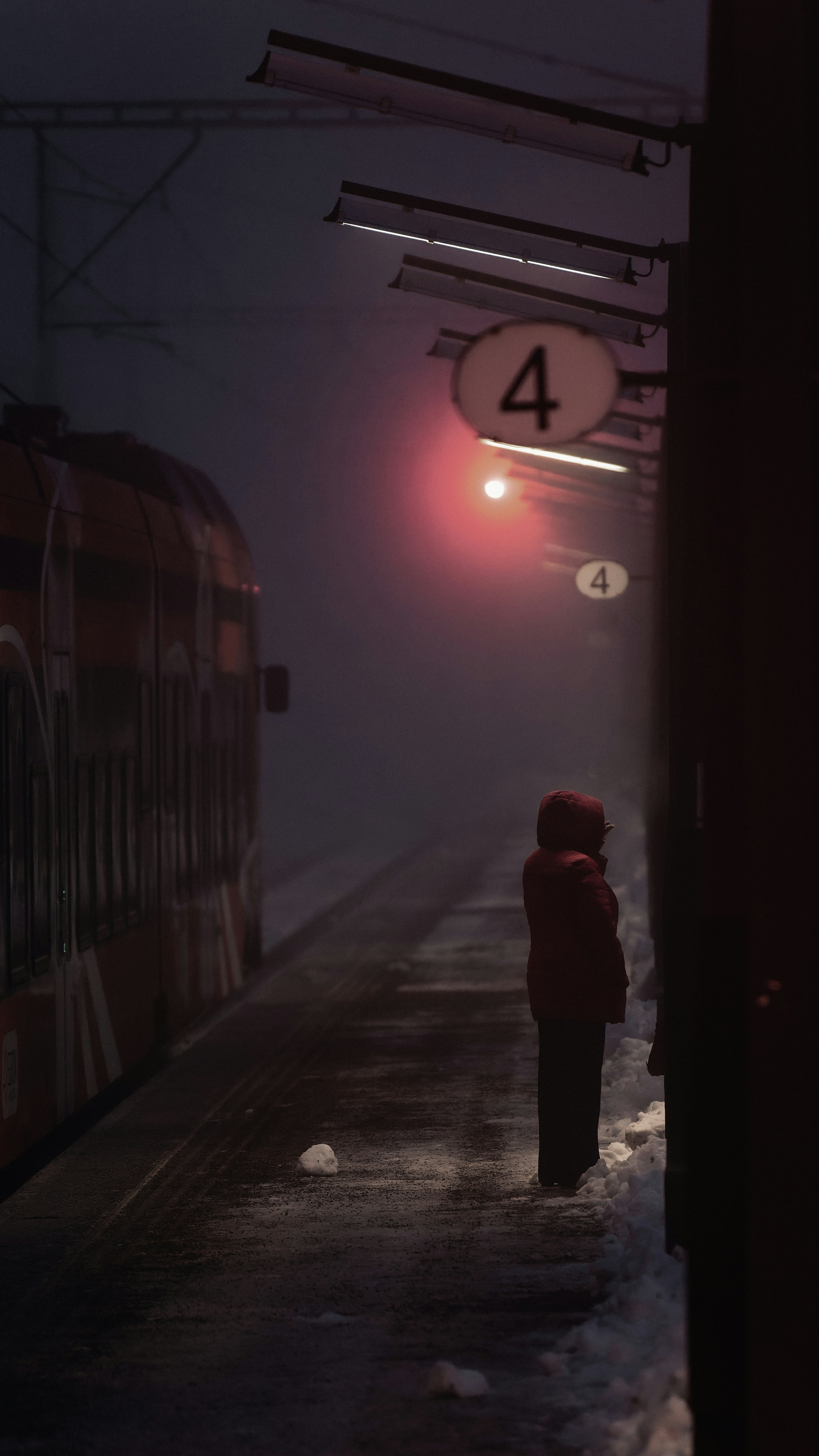 Crimson Quiet: a red-cloaked silhouette on a fog-lit platform under a distant signal