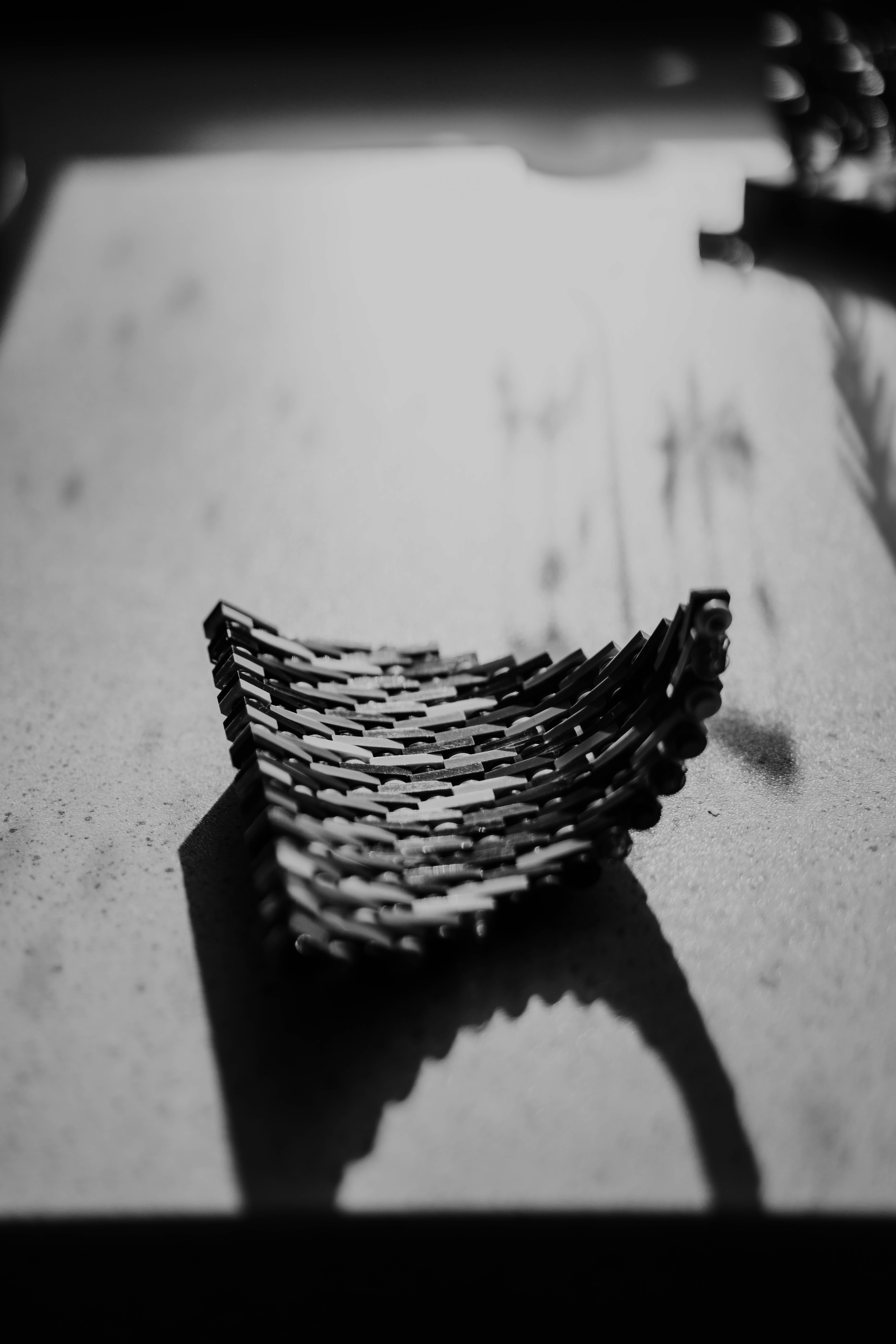 Arc of Weaves: A Woven Seat Cast in Monochrome Shadows
