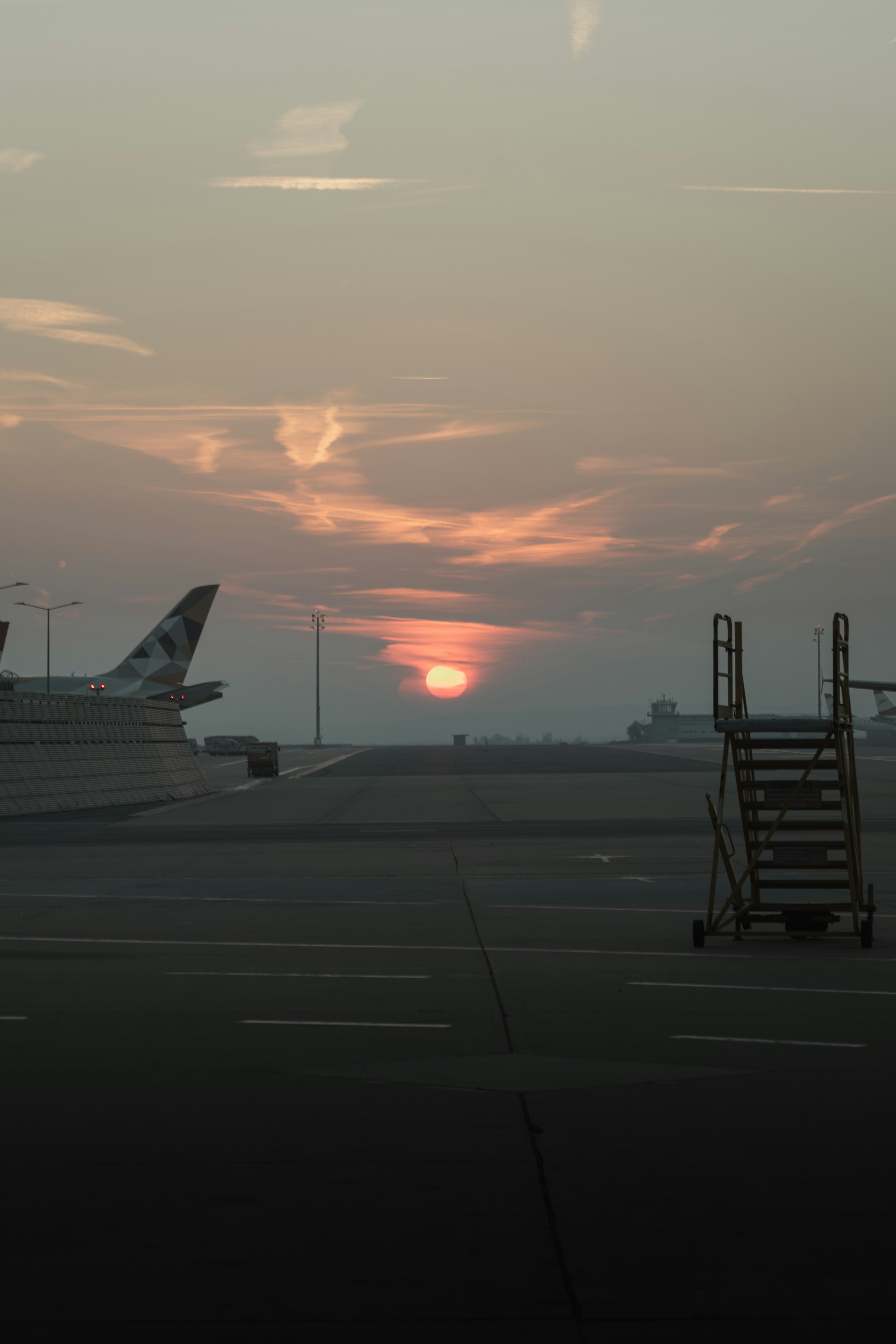 Red Orb on Concrete: Dusk Quiet on the Runway