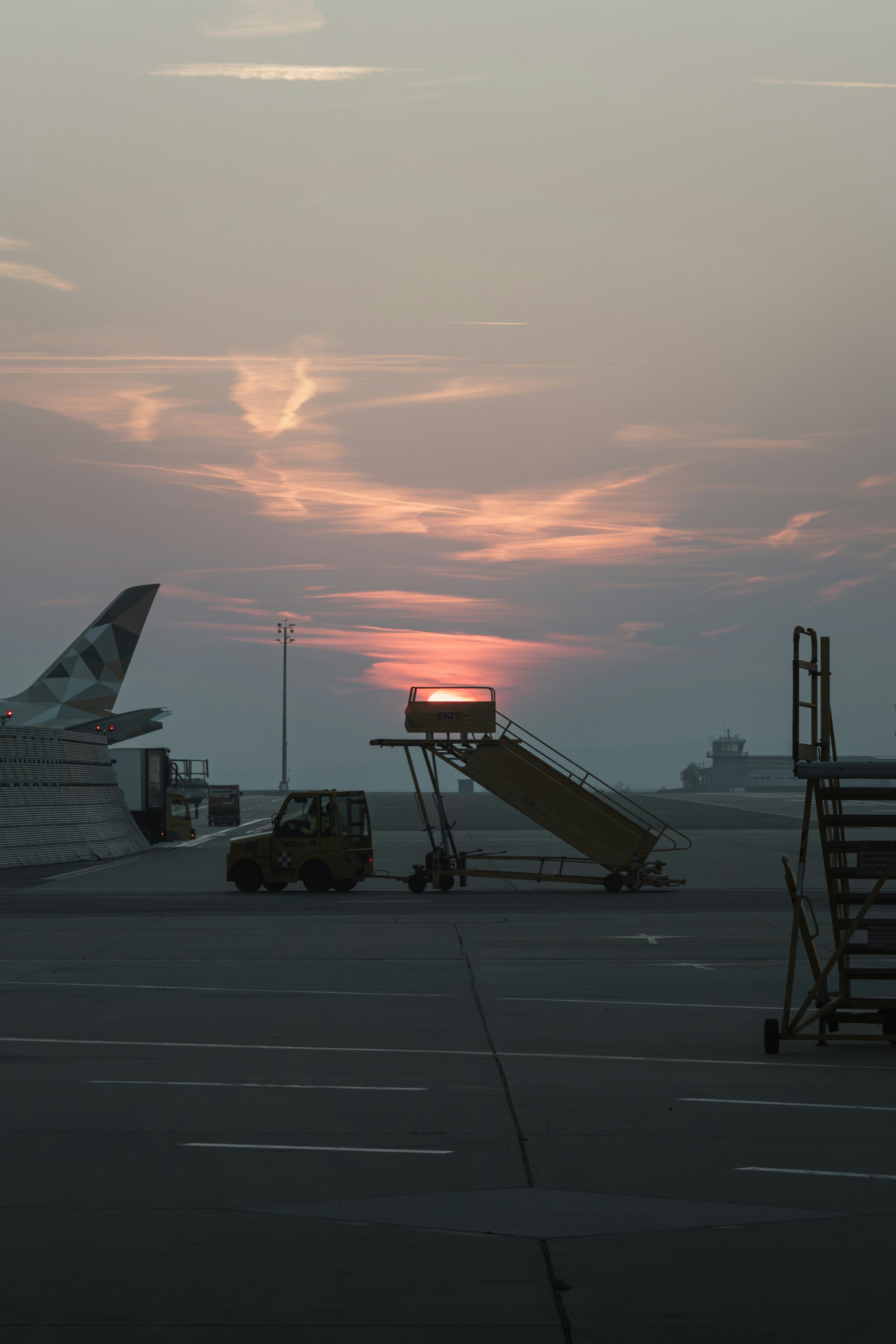 Horizon Burn at Gate: Sunset Glow over the Airport Tarmac