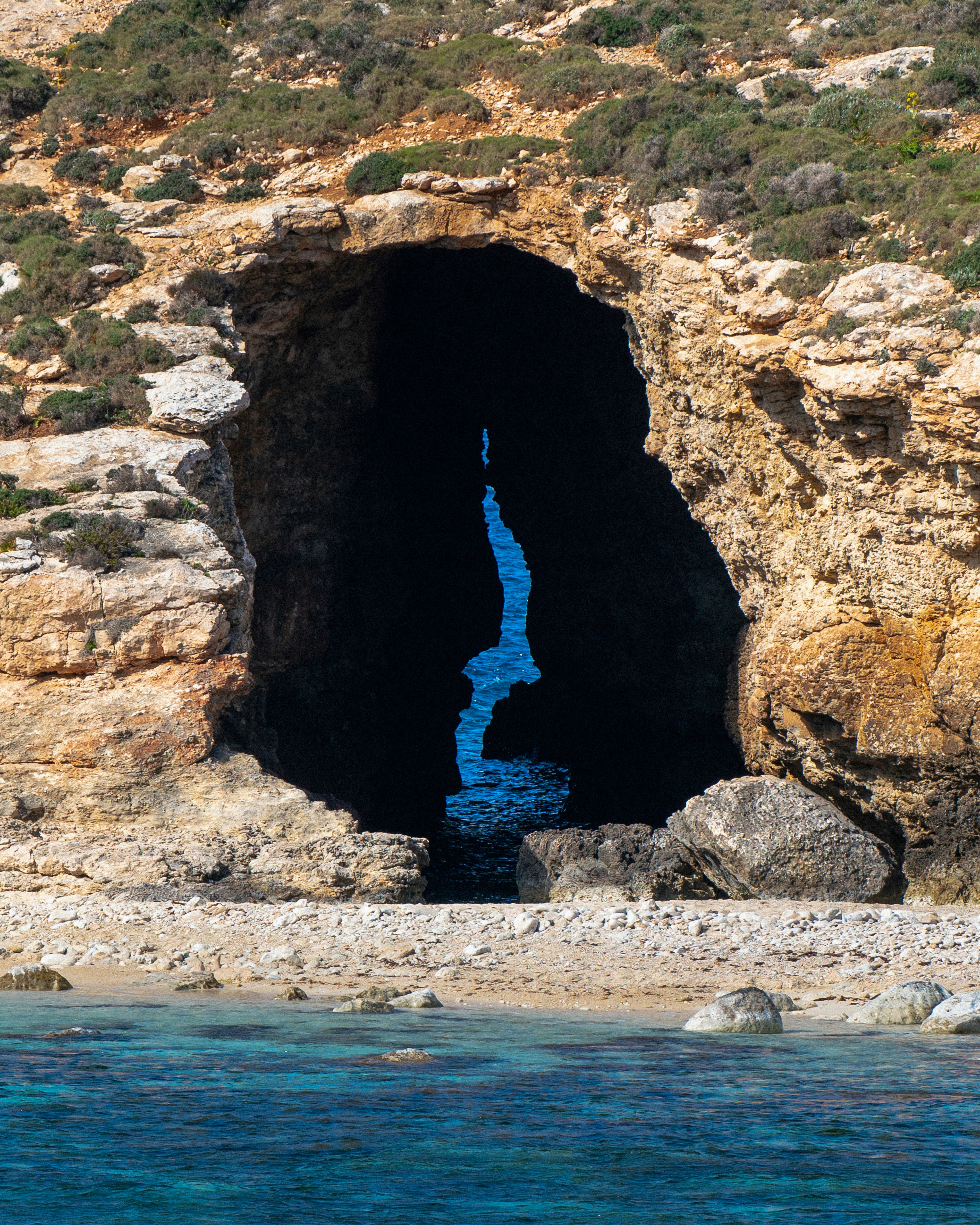 A cave with a blue stream coming out of it photo – Free Nature Image on ...