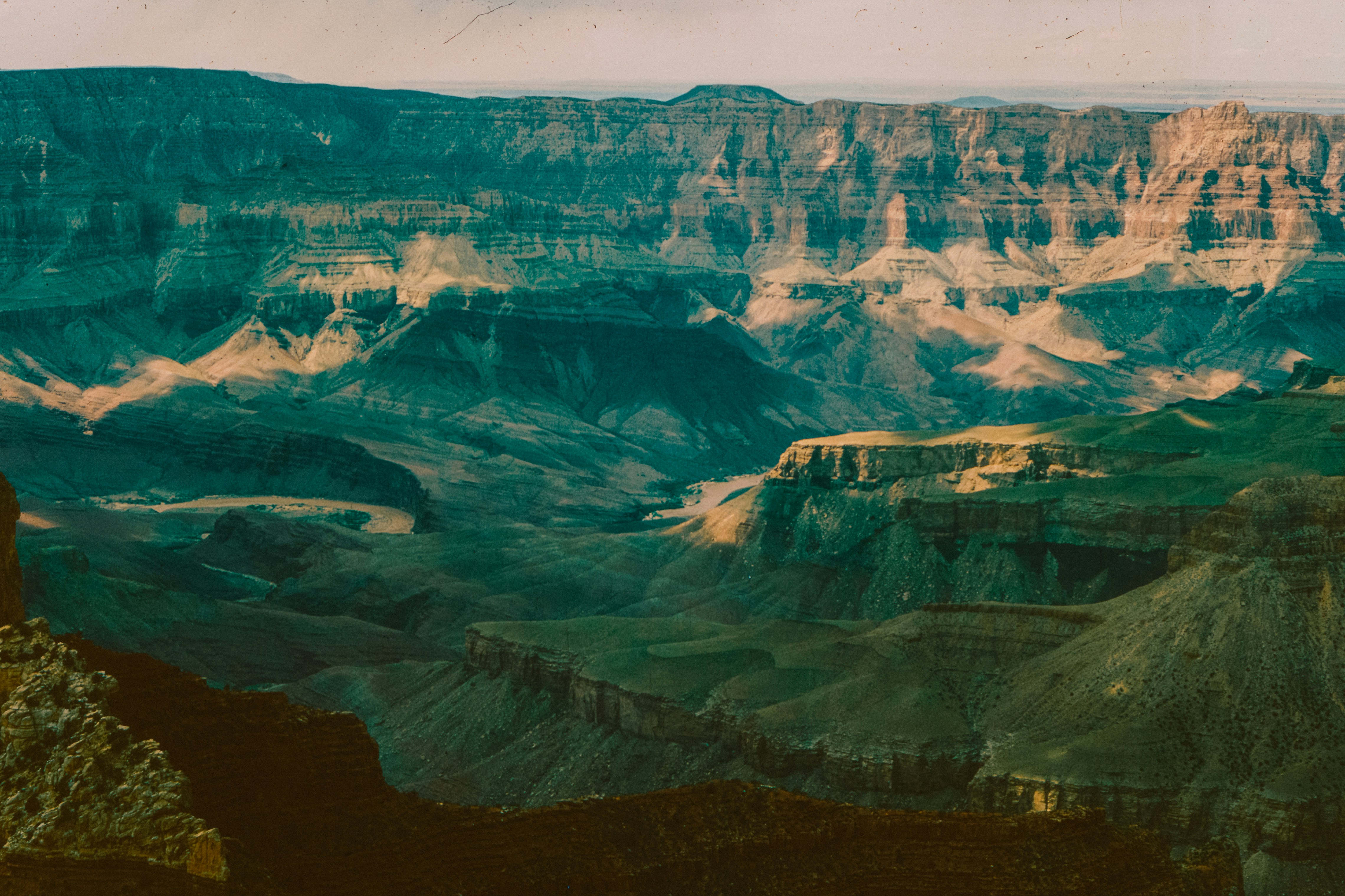 A man standing on top of a large cliff photo – Free Grand canyon Image ...