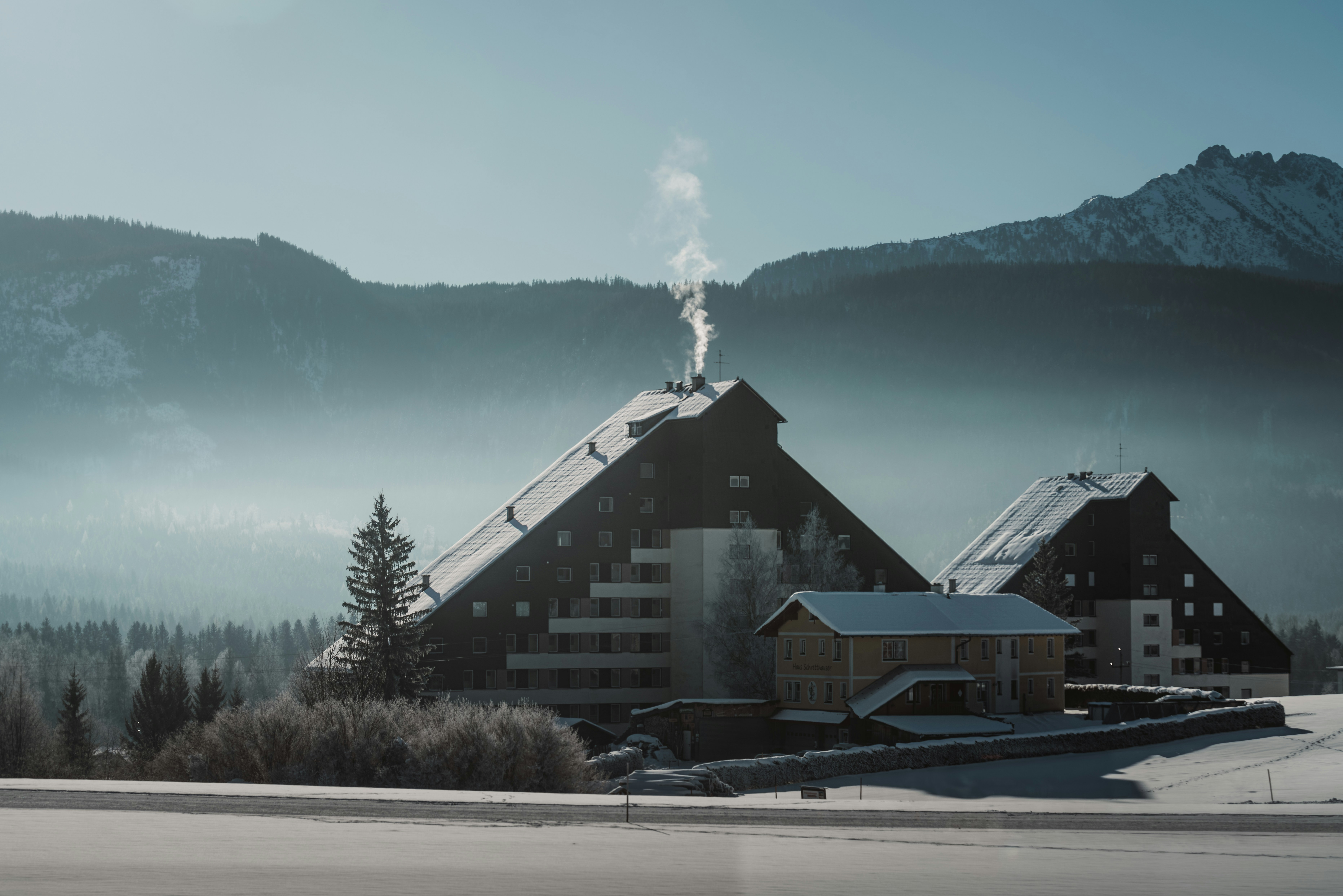 Chalet in Mist: Steam Rising Above Alpine Lodges