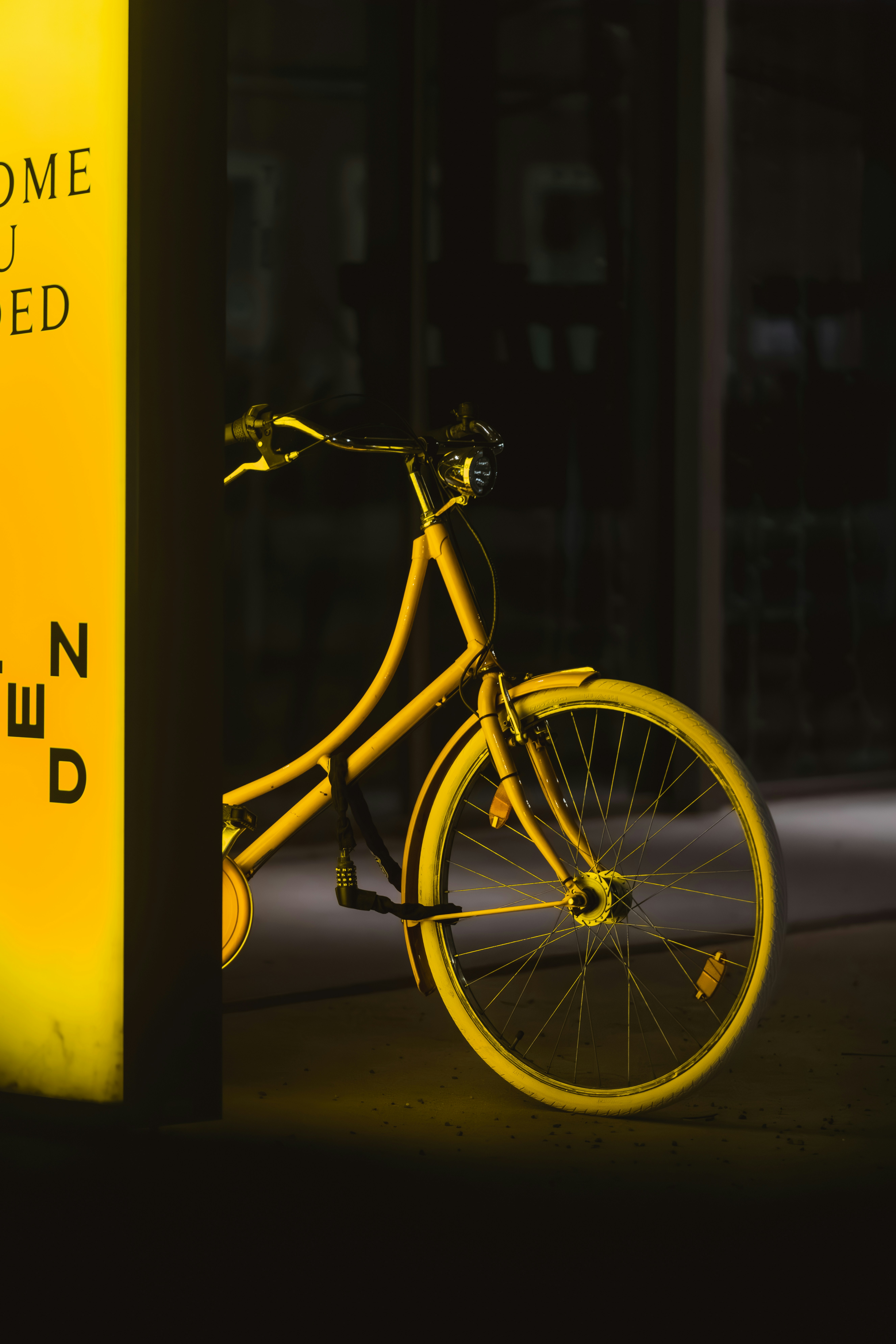 Lone Yellow Bicycle Resting in a Dim Urban Nook