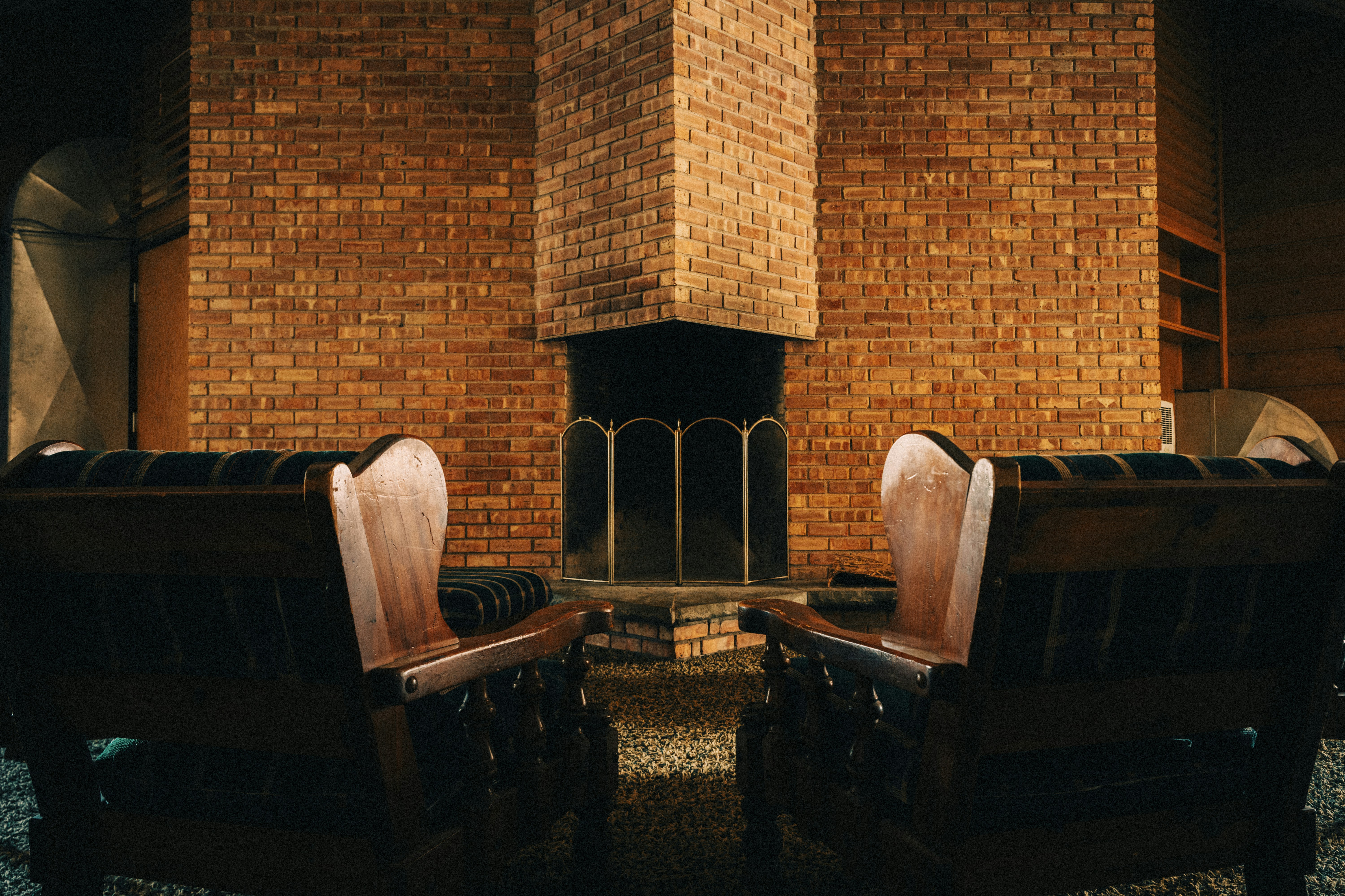 Two chairs facing each other in front of a fireplace photo – Free ...