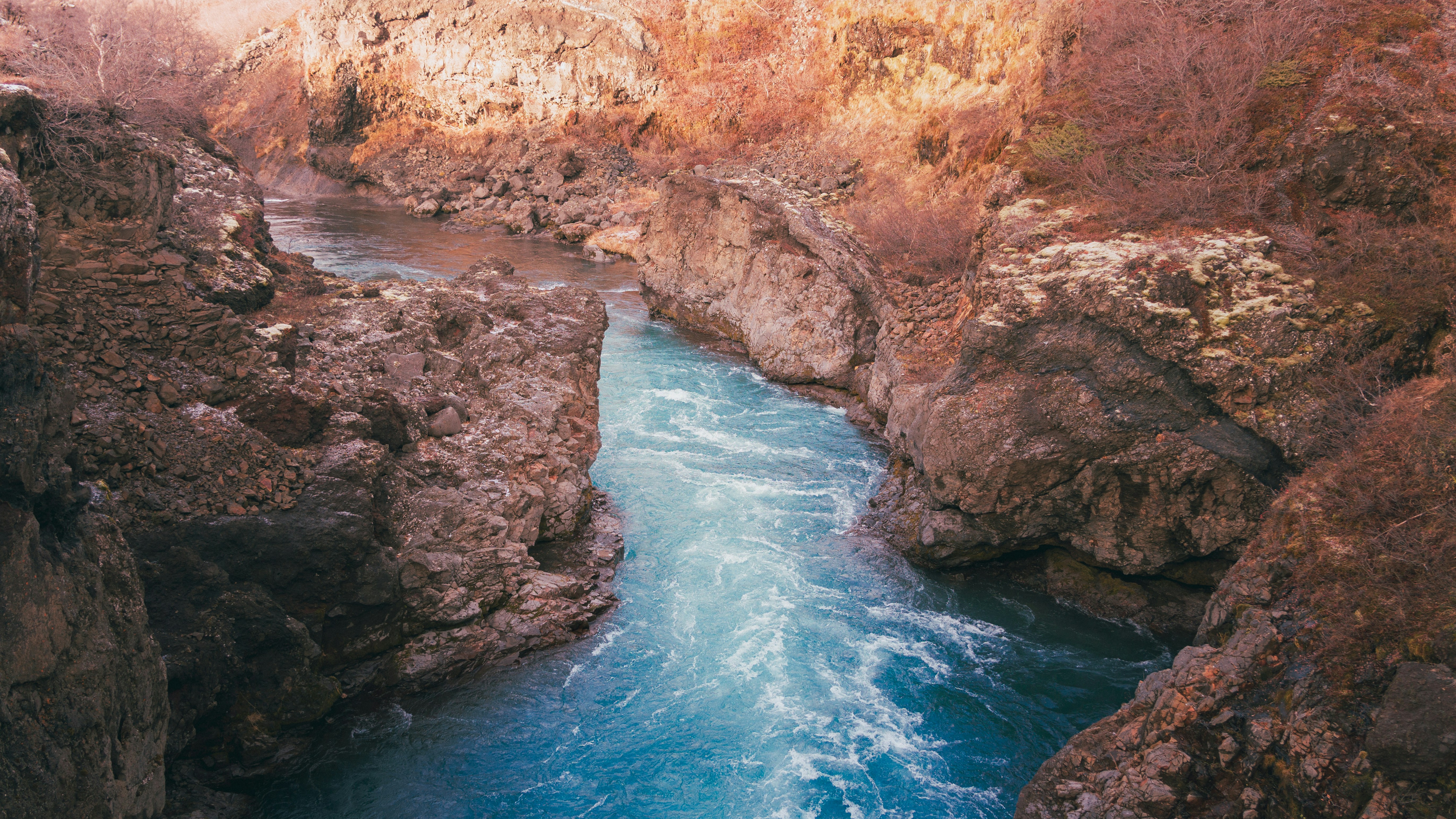 A river flowing through a canyon surrounded by rocks photo – Free Sea ...