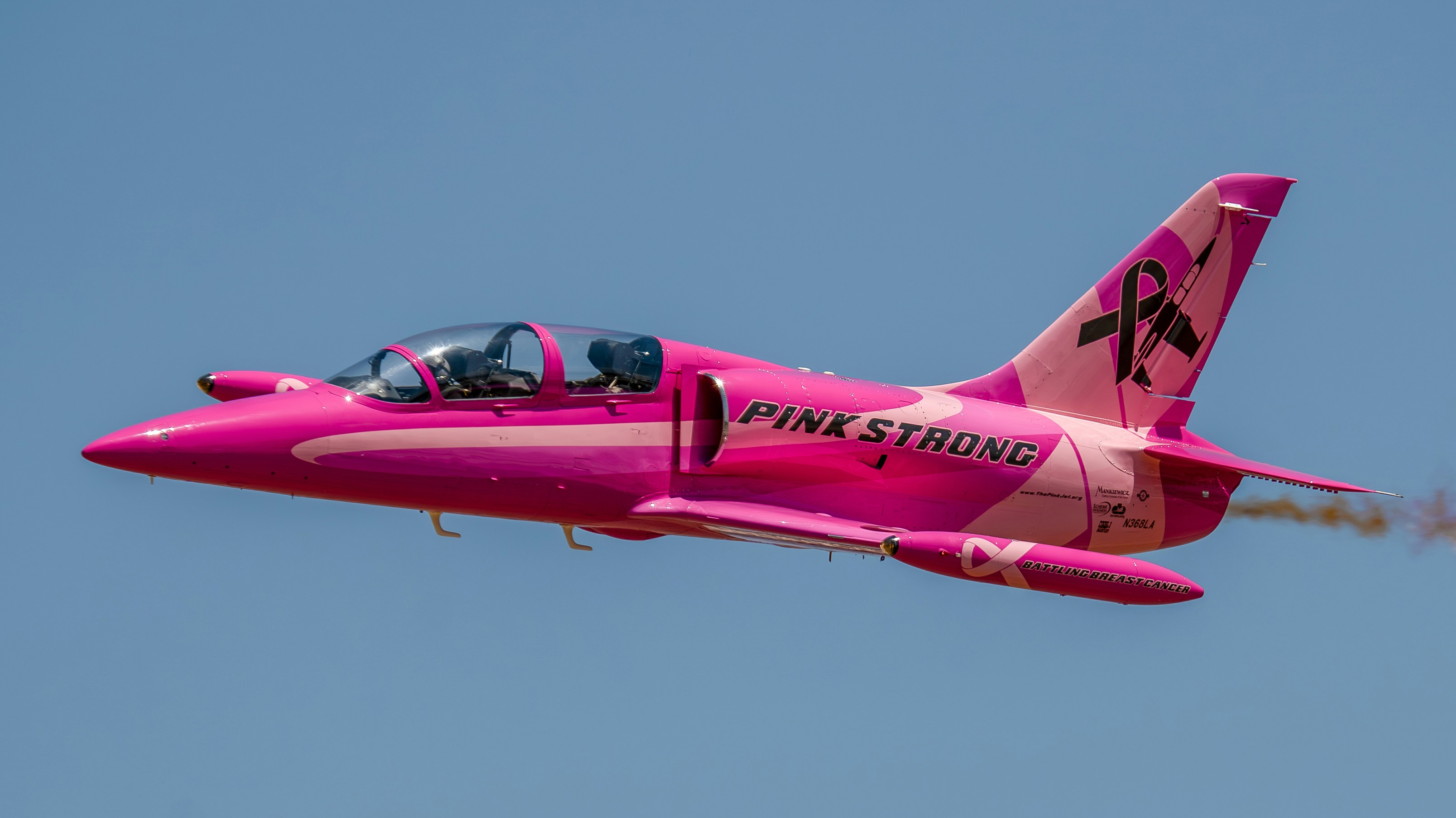 A pink jet flying through a blue sky photo – Free Airplane Image on ...