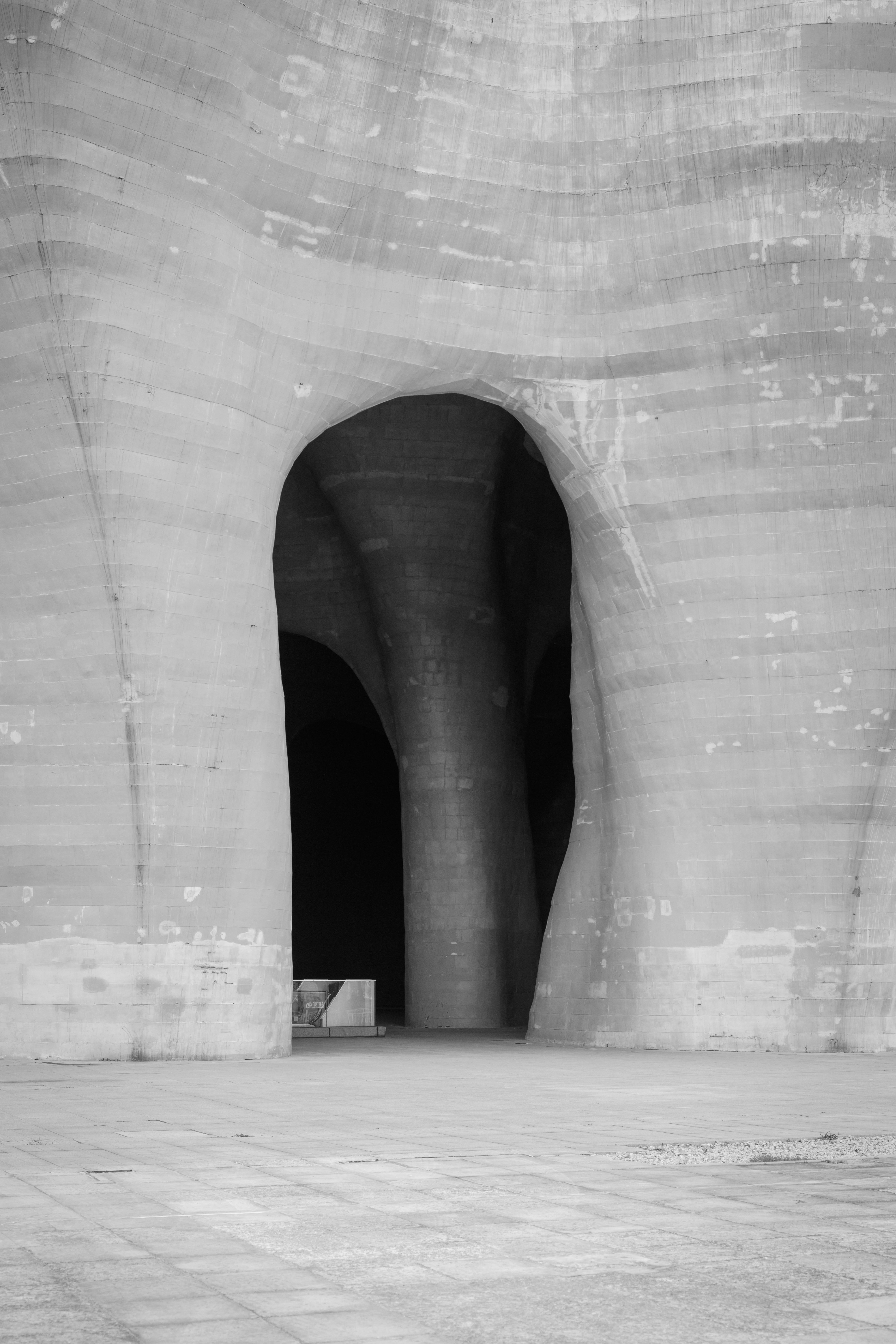 The Shadow Gate: Monolithic Archway Framing a Dark Inner Corridor