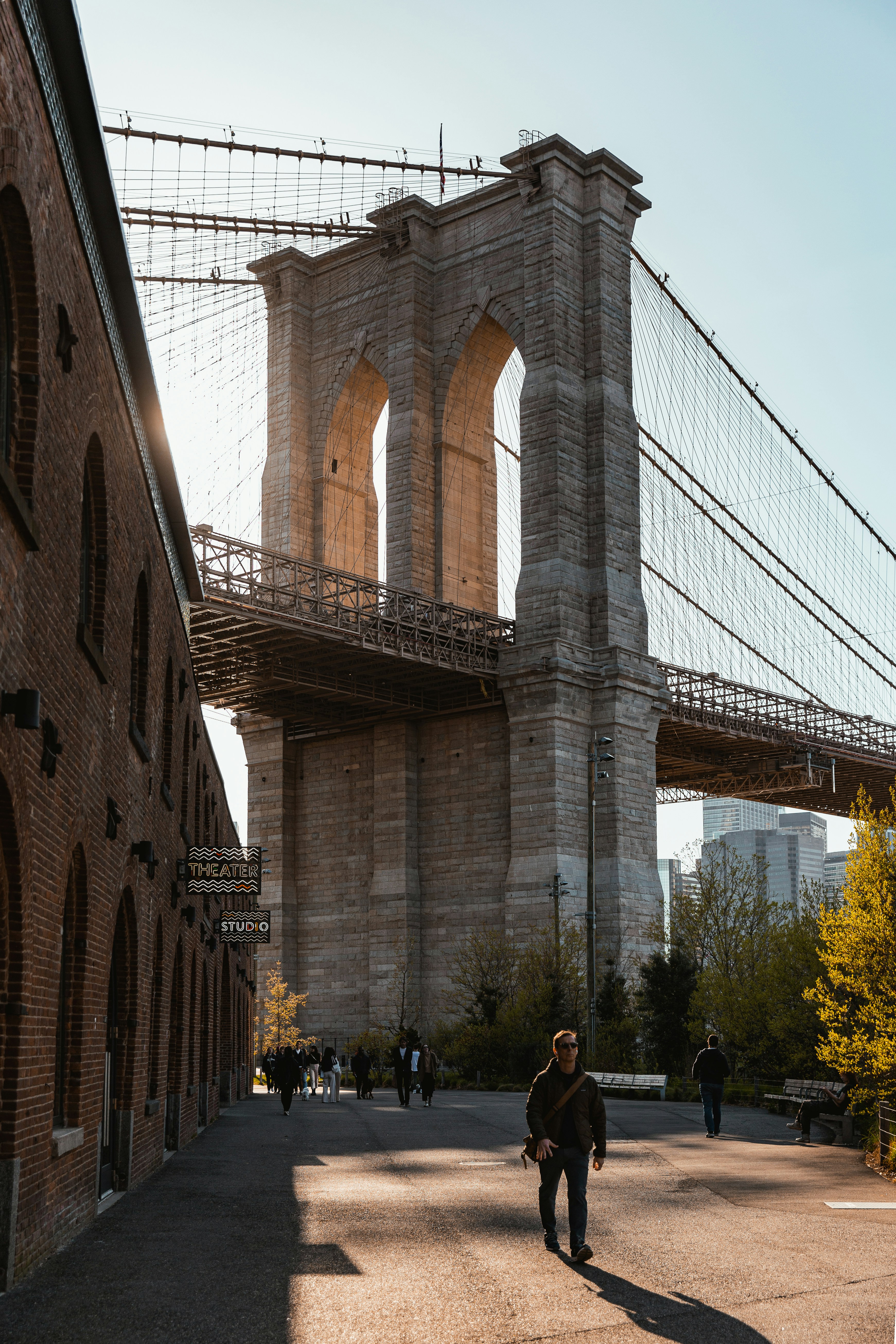 Golden Hour Promenade Beneath the Brooklyn Bridge Towers