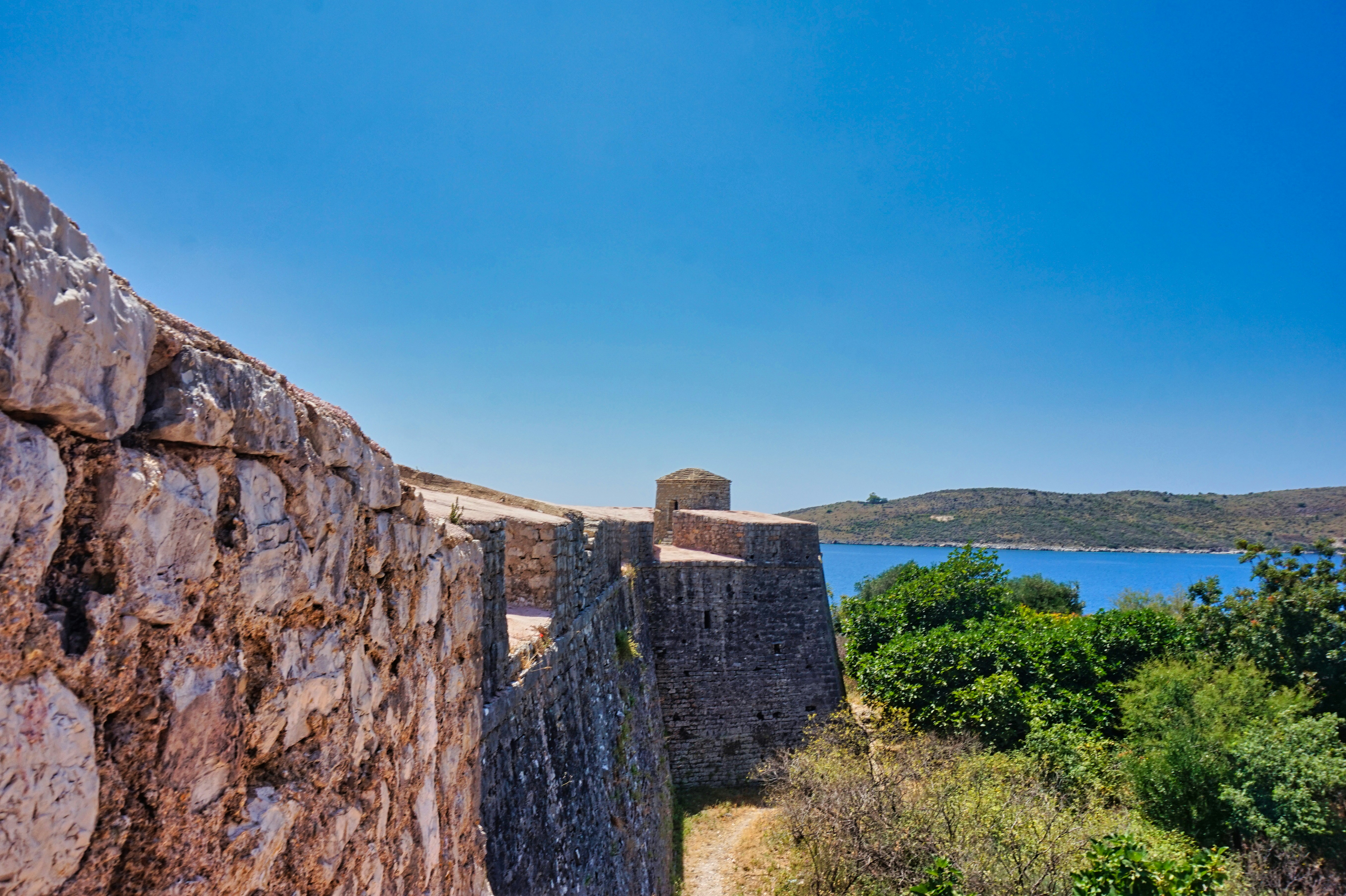 Salt-Stone Sentinel: Coastal Bastion Reaching Toward a Blue Horizon