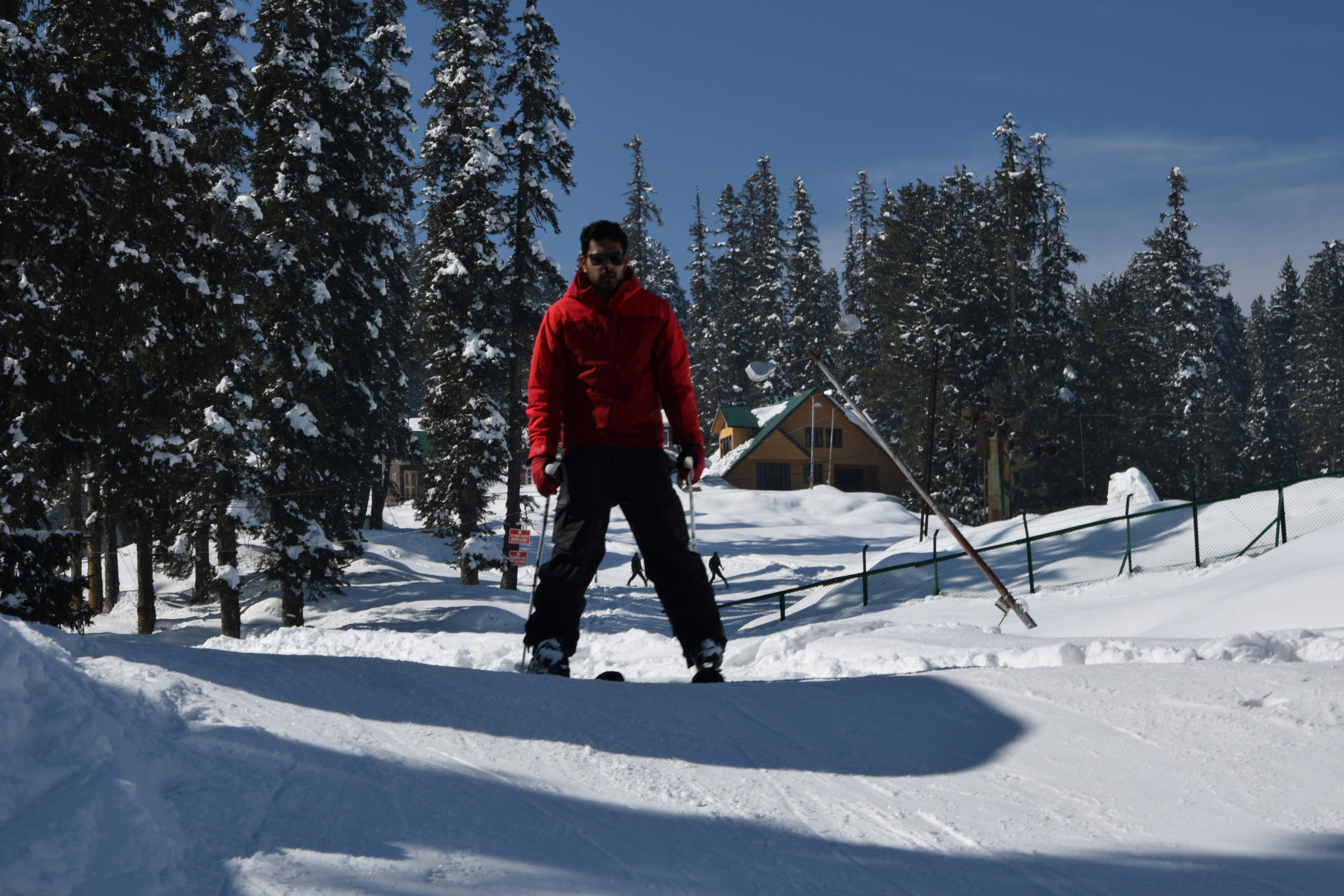 Red-Suited Explorer in Snow-Crowned Forest