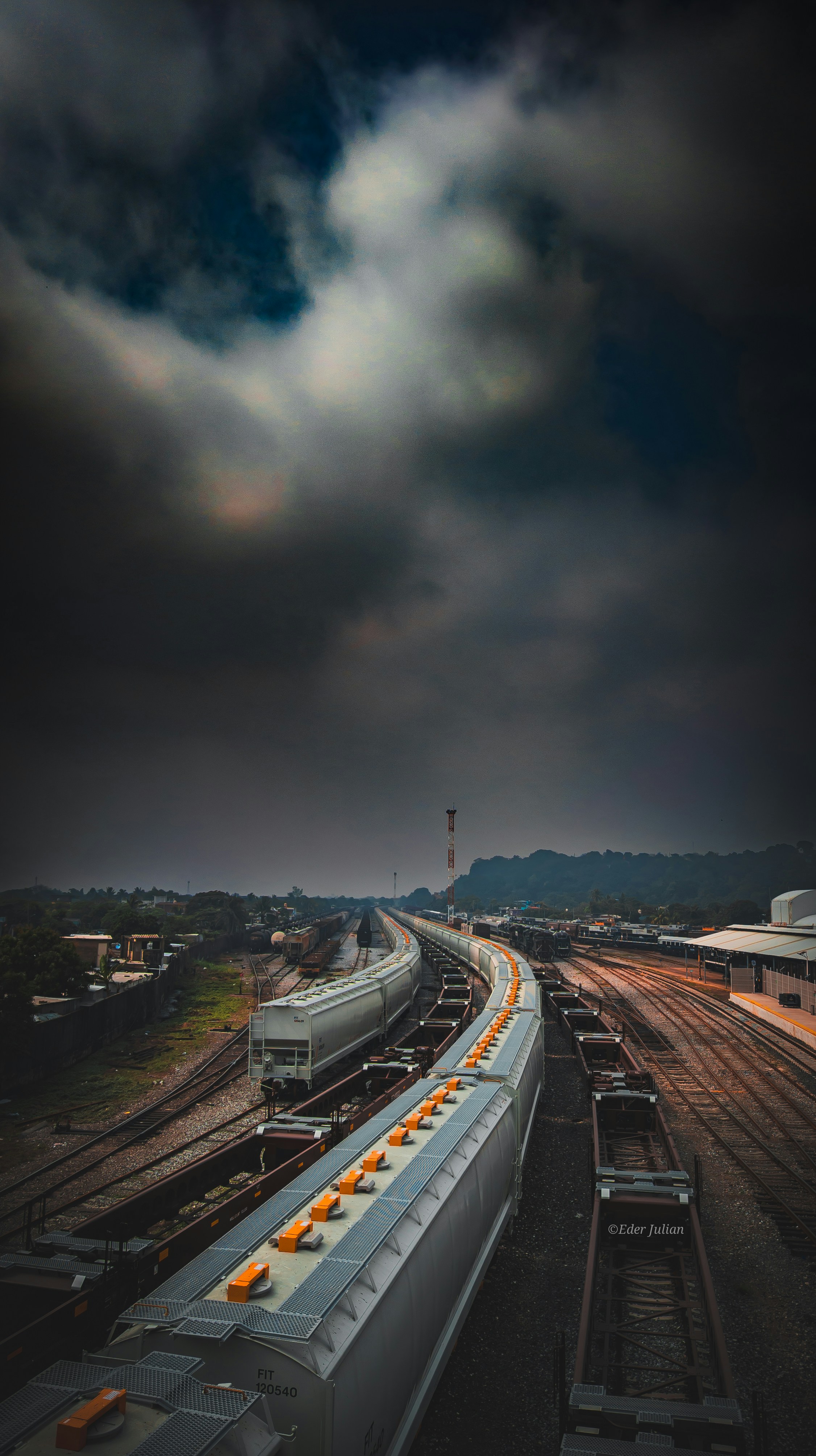 Converging Rails Beneath a Storm-tinged Sky