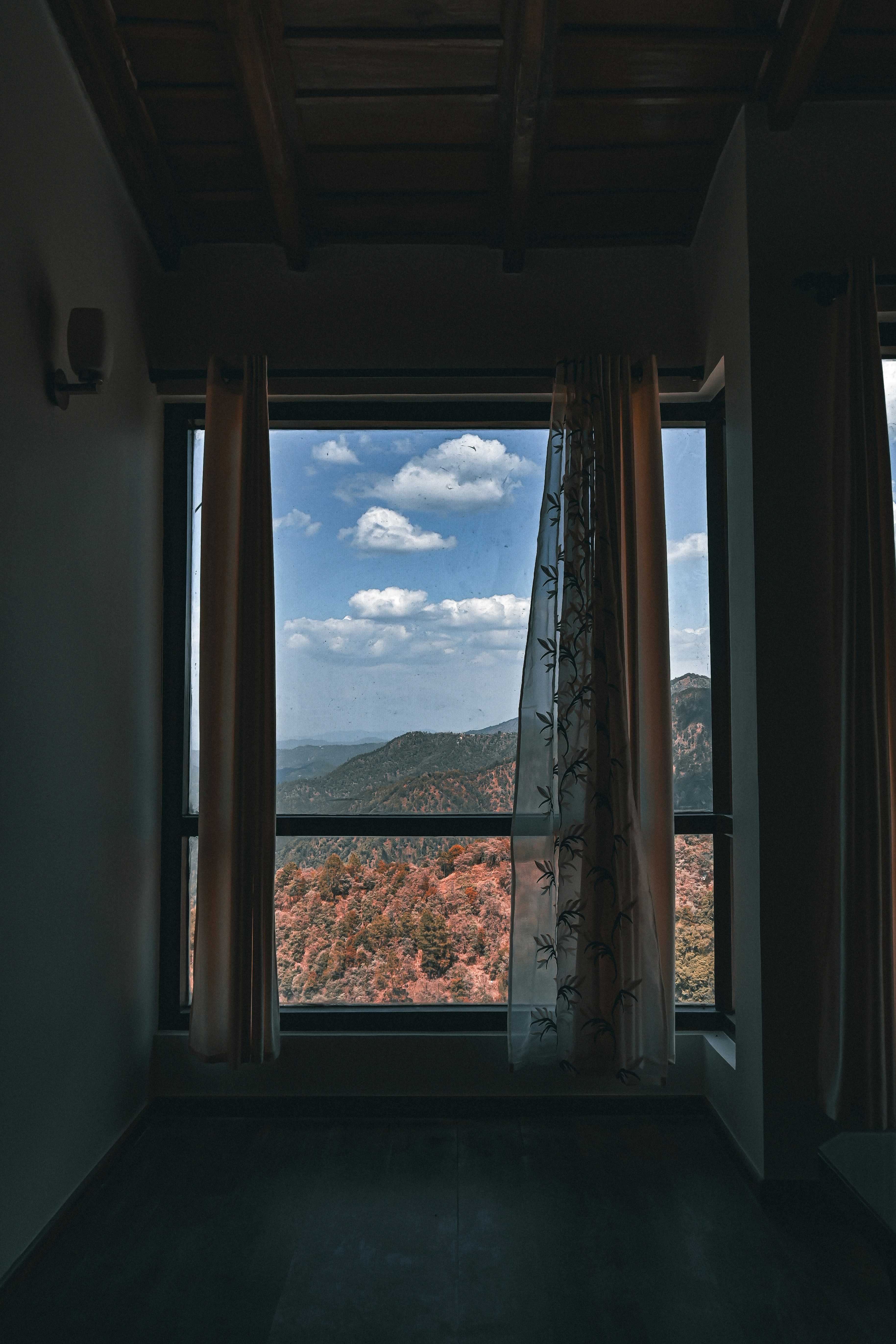 A Quiet Vantage: Mountain Vista Framed by Curtains
